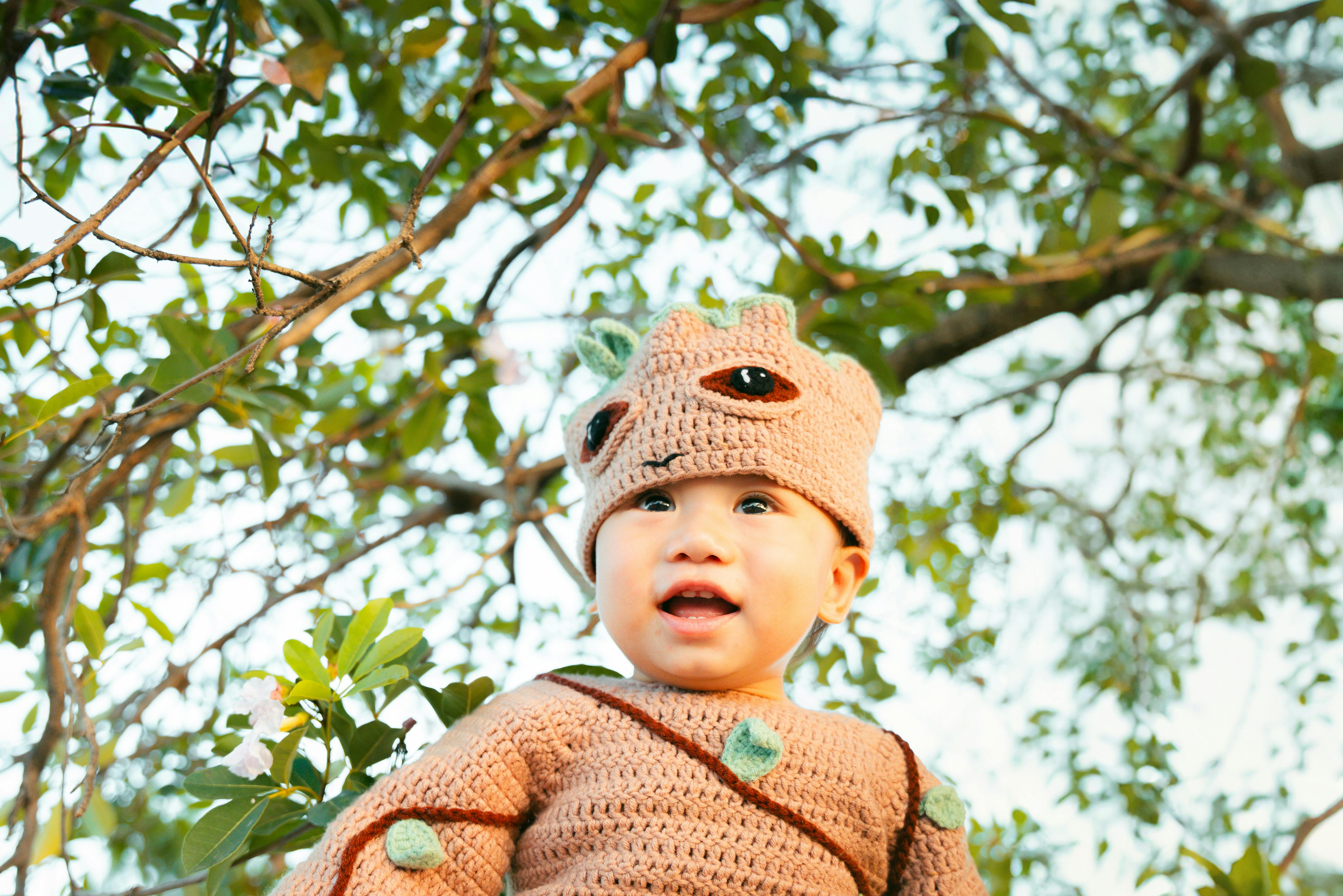 Little Baby Wearing Woolen Costume on a Meadow · Free Stock Photo