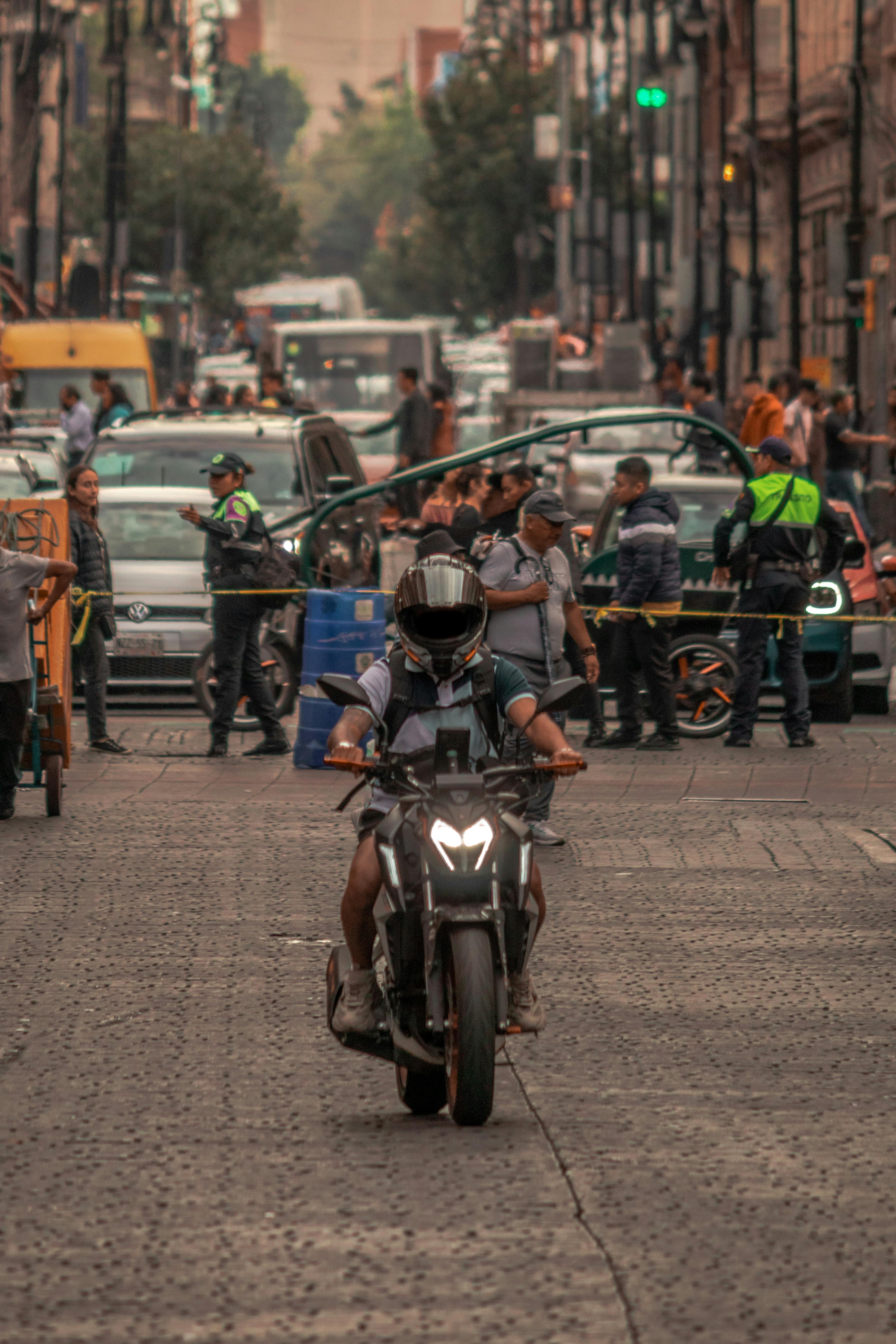 A Motorcyclist Riding on a Busy Street in a City · Free Stock Photo