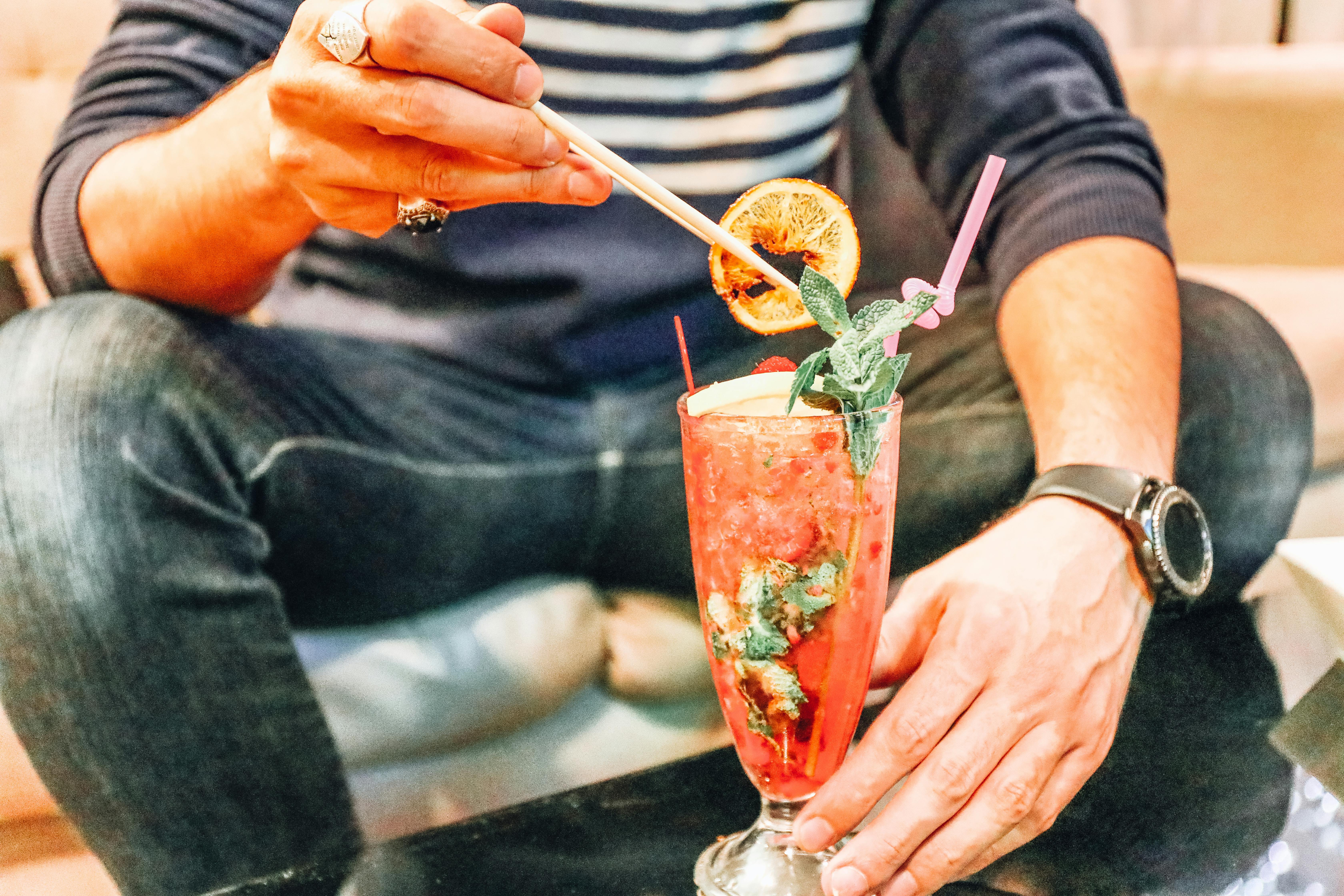 Person Pouring Drink from Coconut · Free Stock Photo
