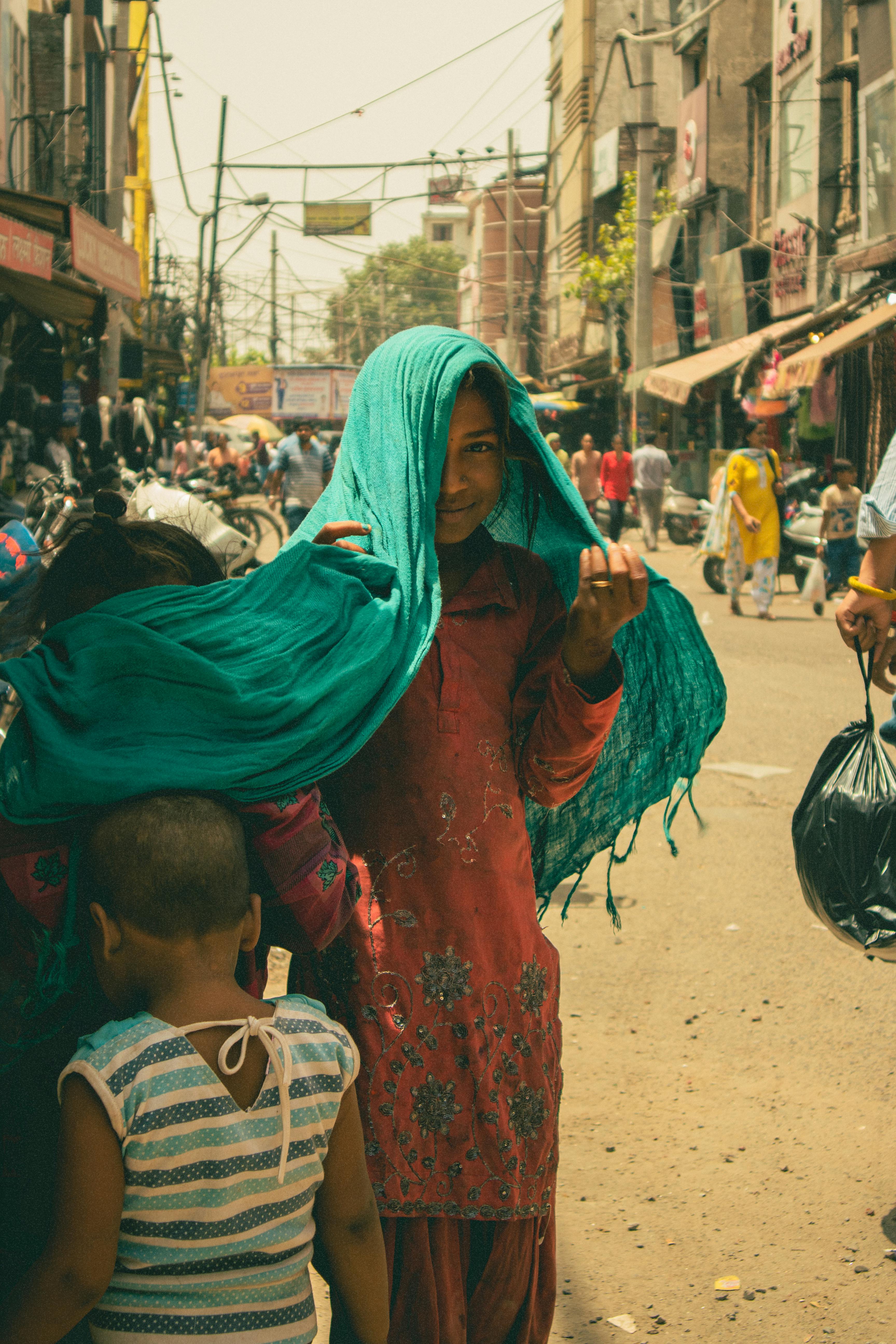 Girl Standing in Shawl on Street · Free Stock Photo