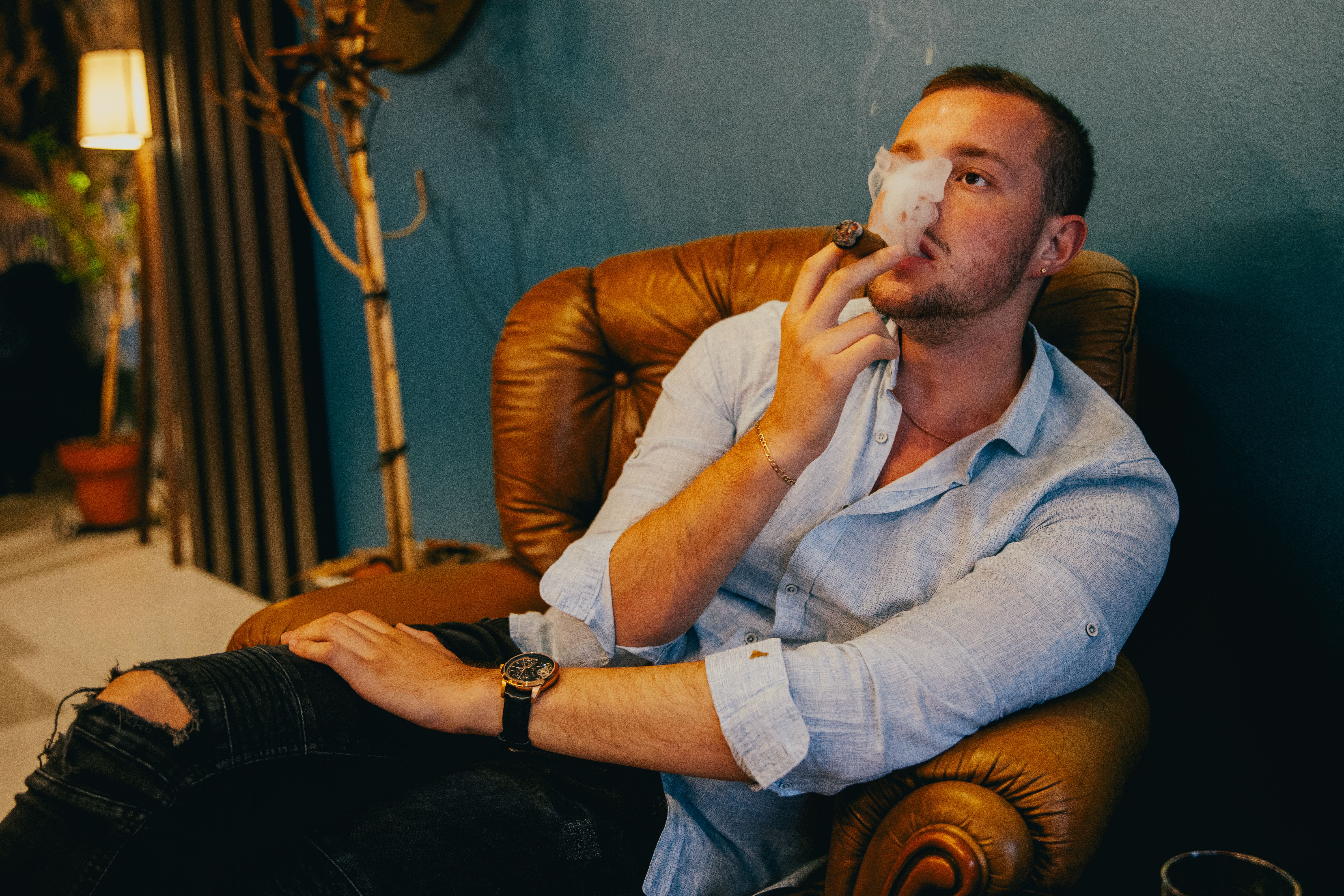 Man Sitting i Armchair Smoking Cigar · Free Stock Photo