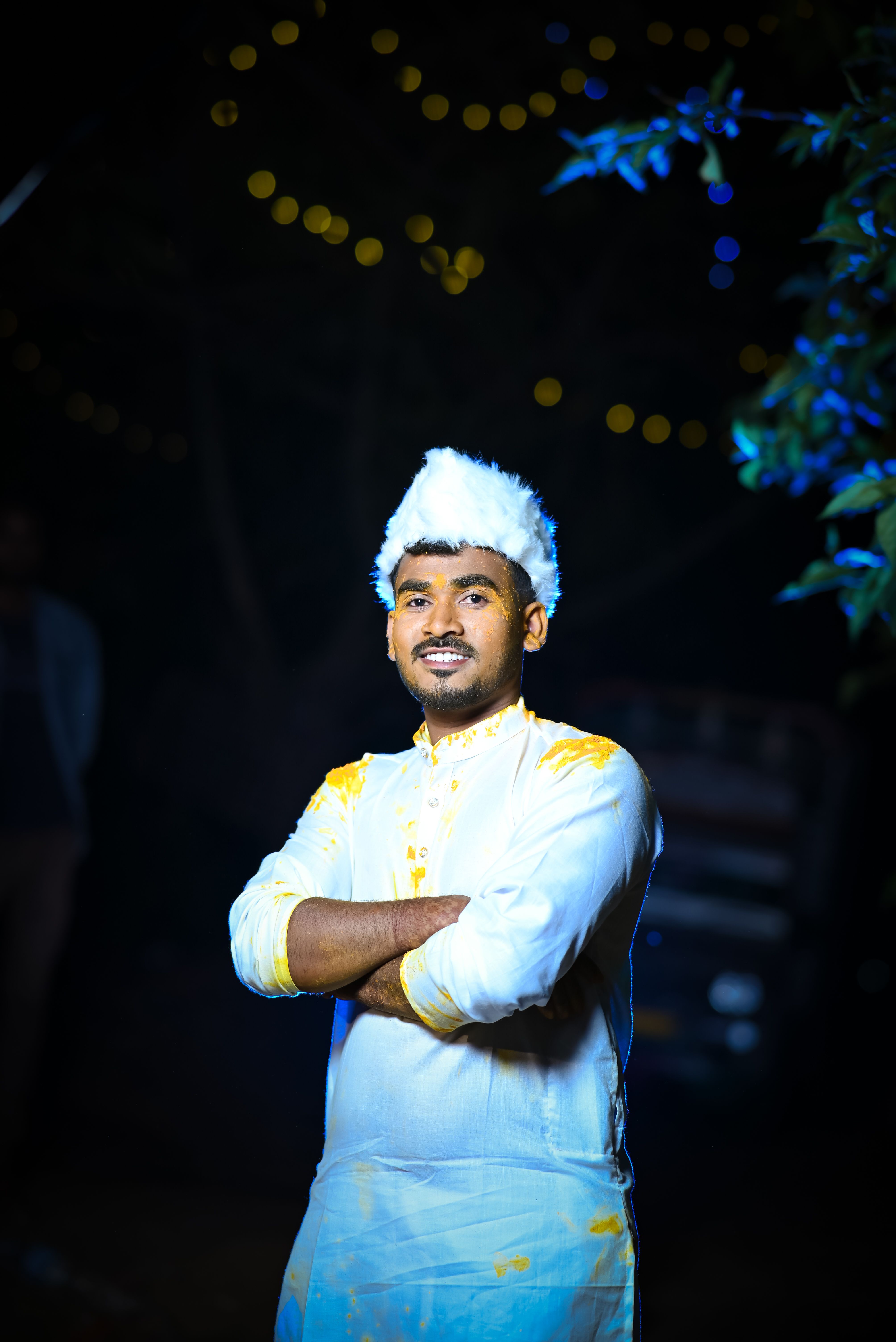 A Man Wearing a Traditional Attire while Standing Outside at Night ...