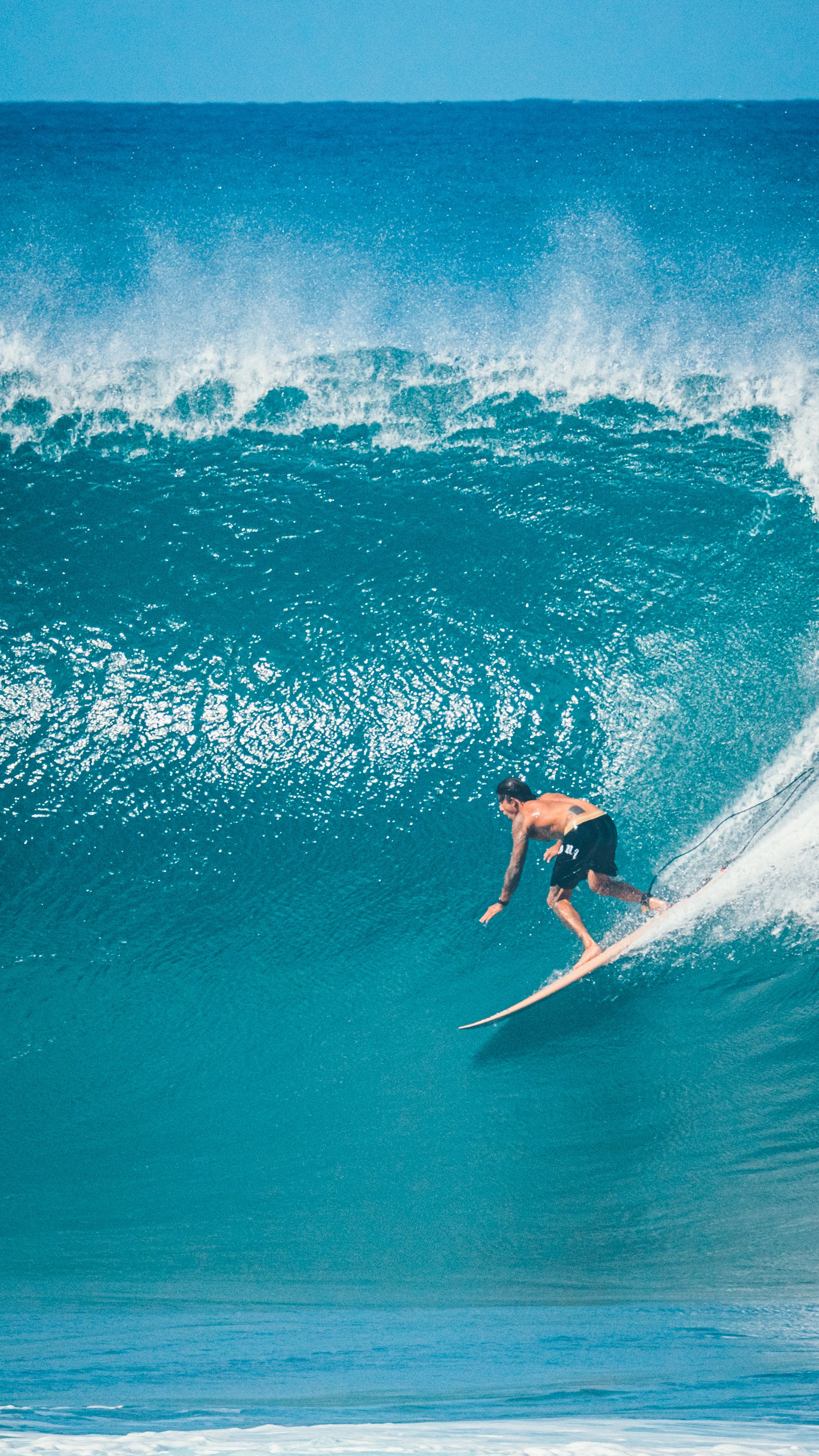 Vertical Shot of a Man Riding a Wave · Free Stock Photo