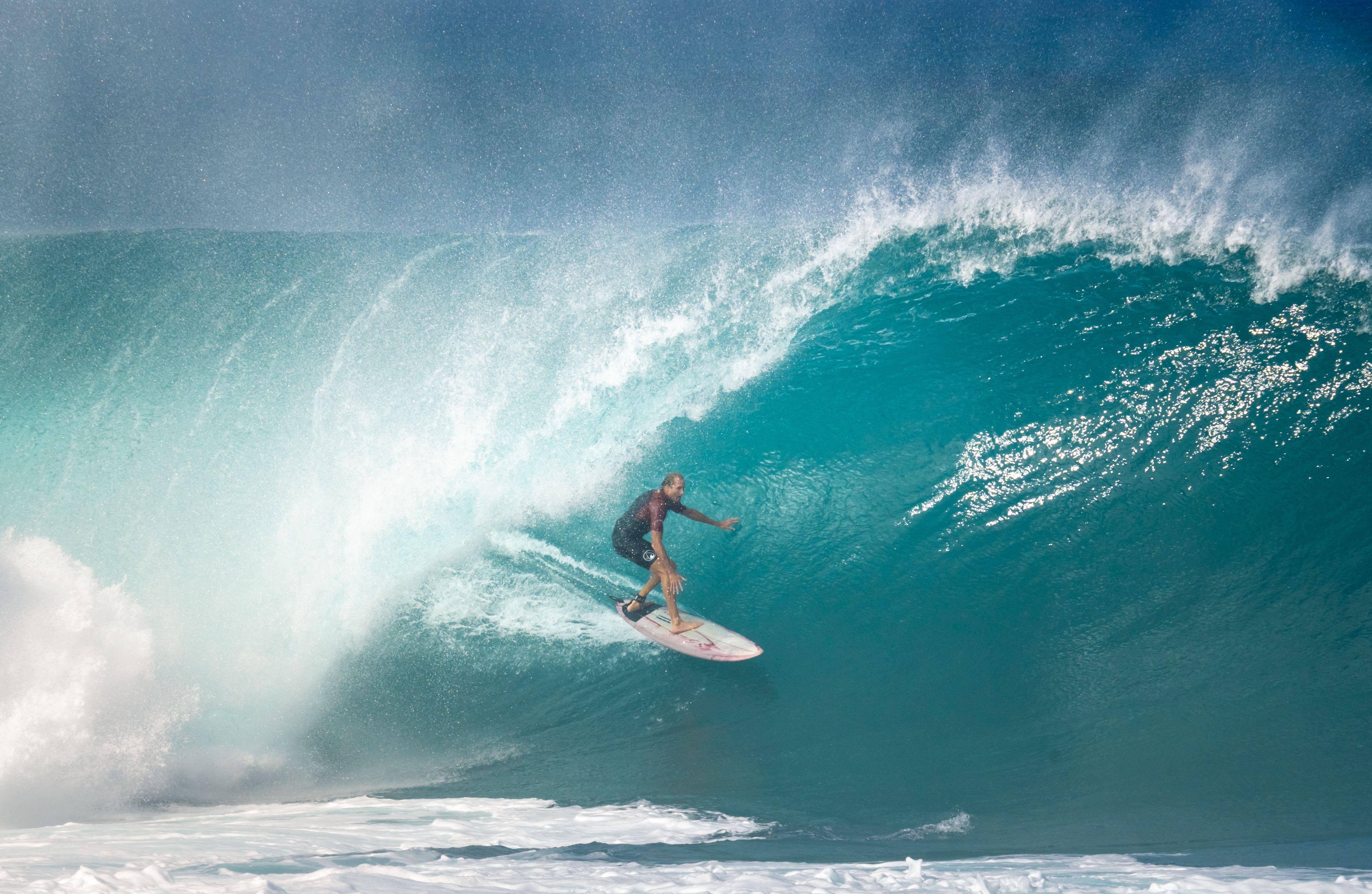 A surfer riding a large wave in the ocean · Free Stock Photo