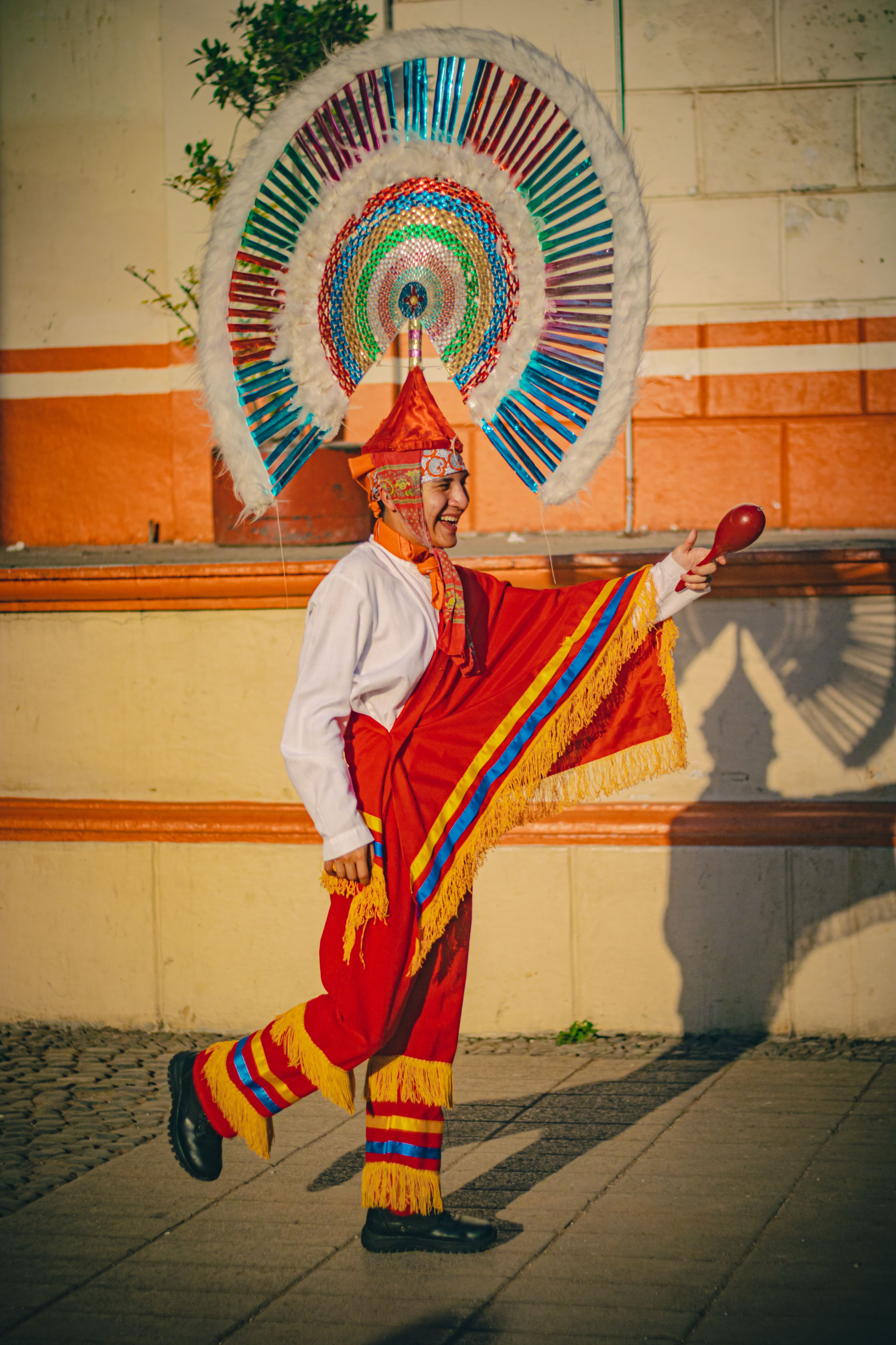A Quetzal Dancer in Traditional Clothing at a Festival · Free Stock Photo
