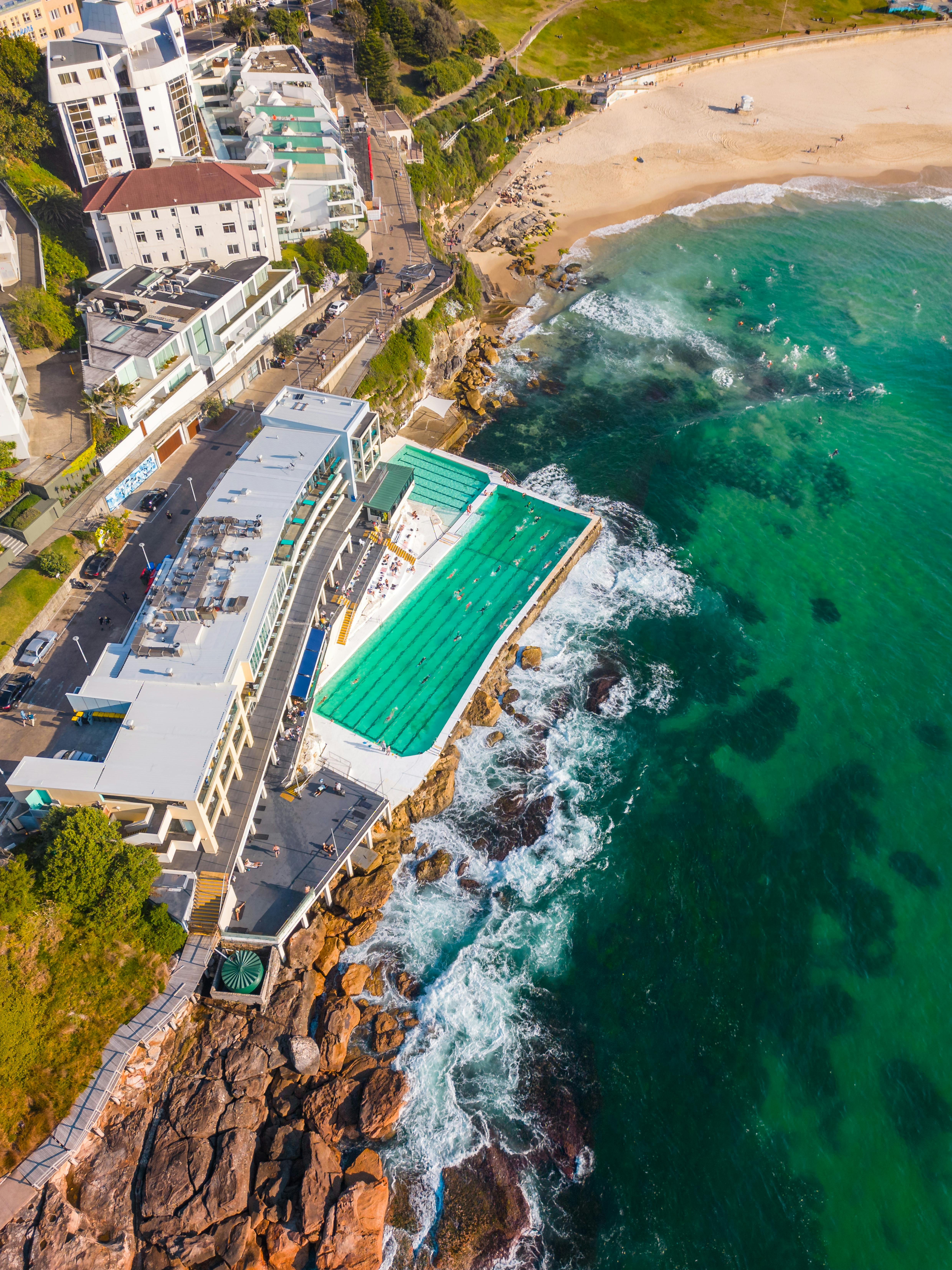 Aerial View of Beach Resort Built on Rocky Coastline · Free Stock Photo