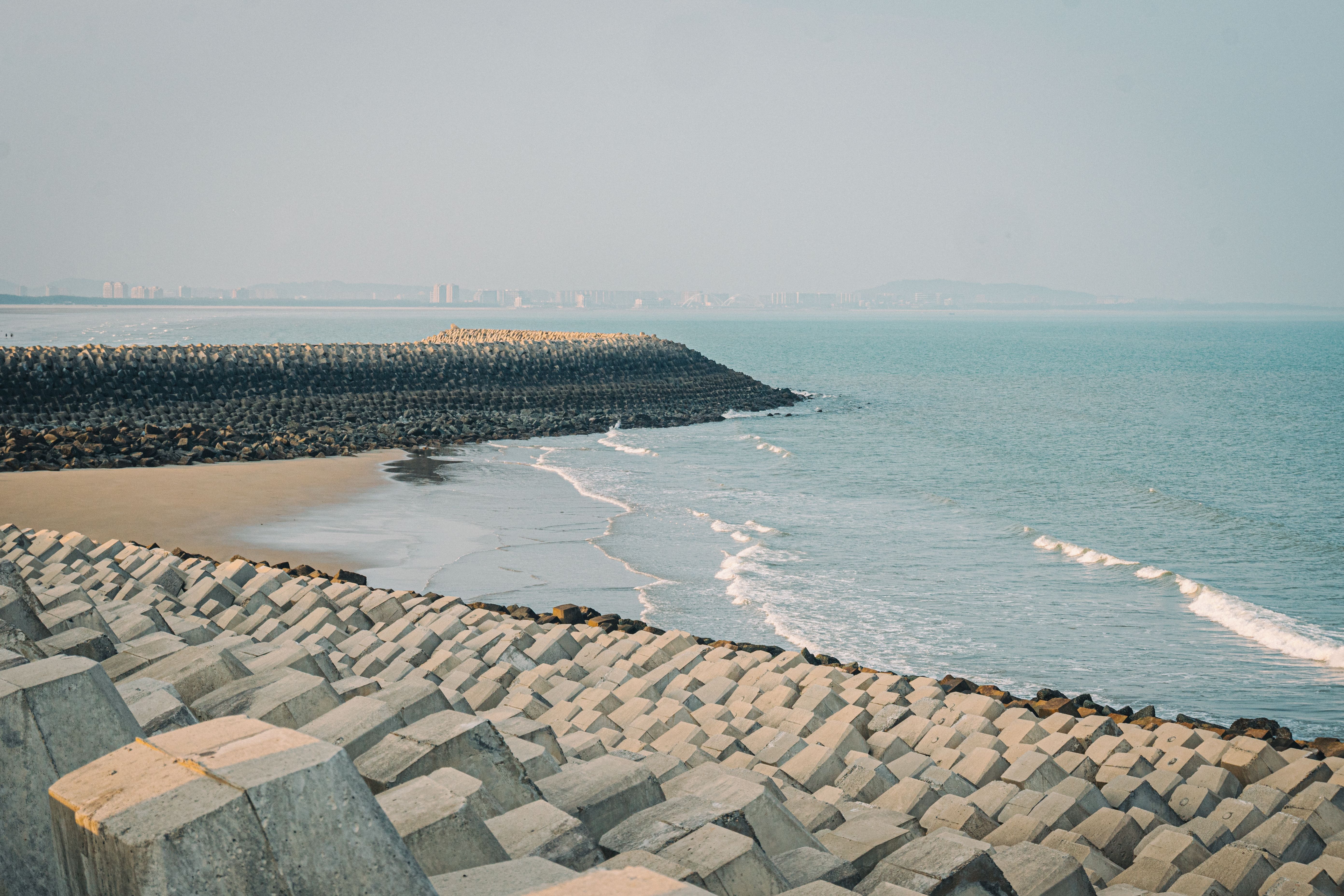 Empty Beach and Concrete Water Breakers · Free Stock Photo