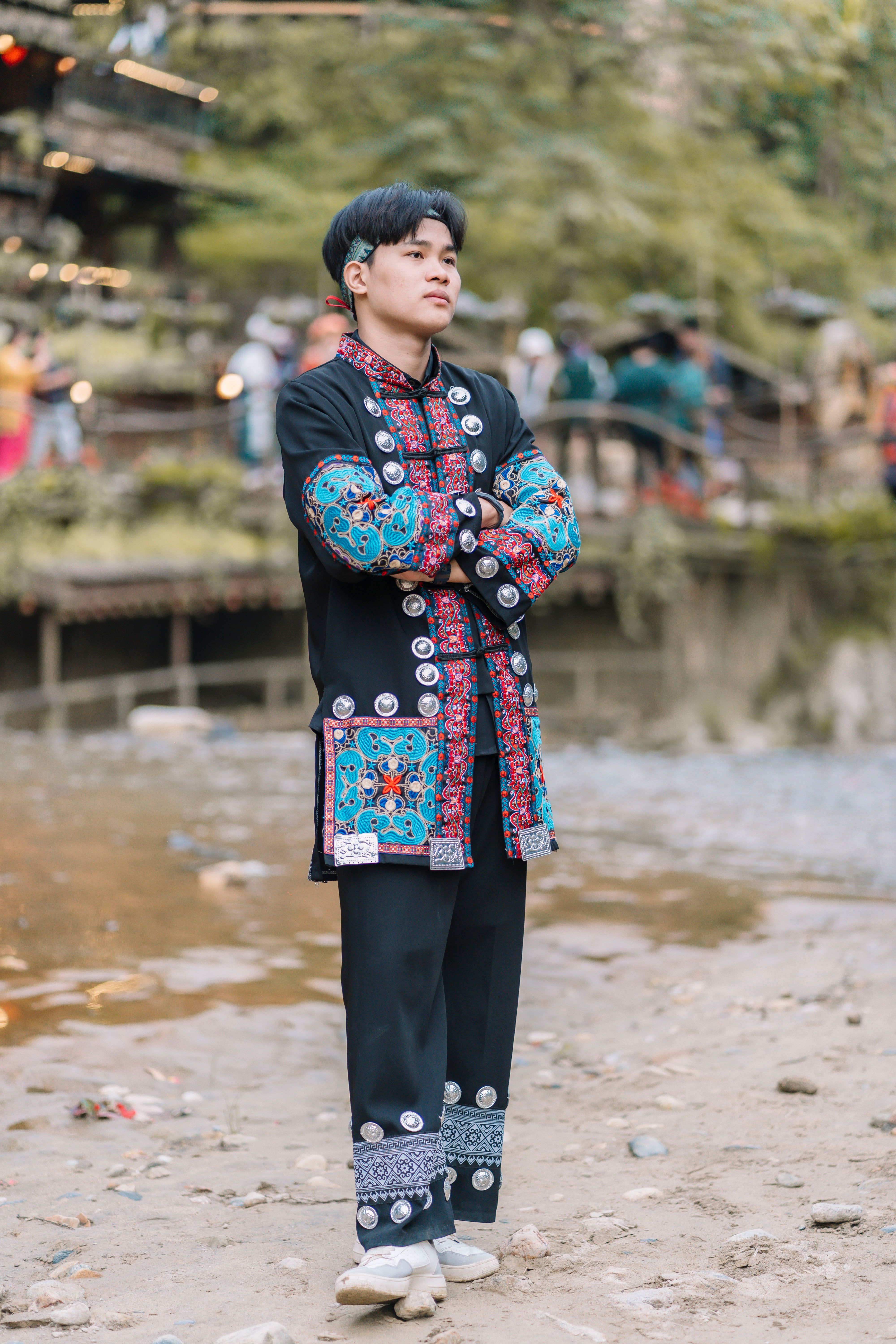 A man in traditional clothing standing in front of a river · Free Stock ...