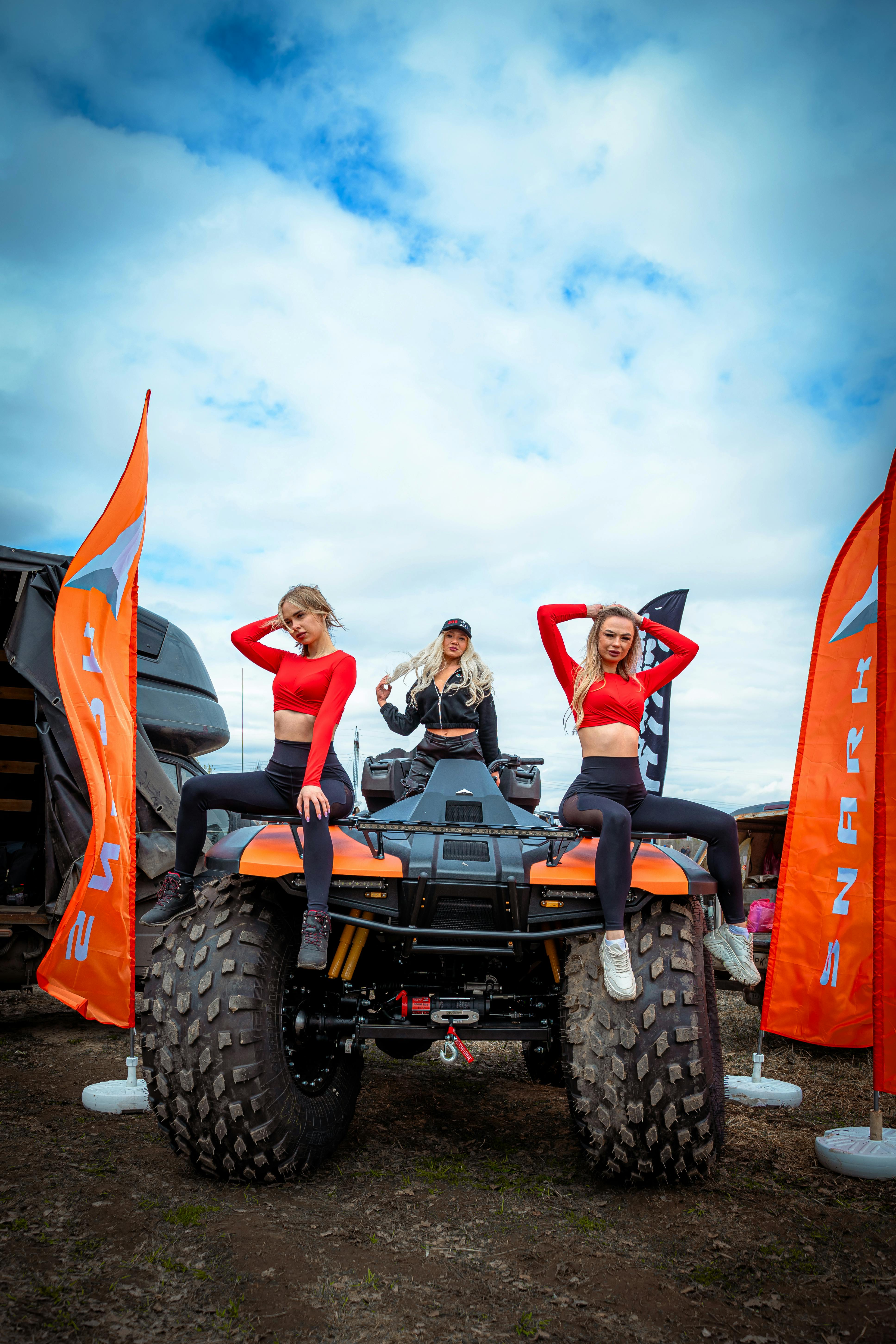 Three women posing on a four wheeler atv · Free Stock Photo