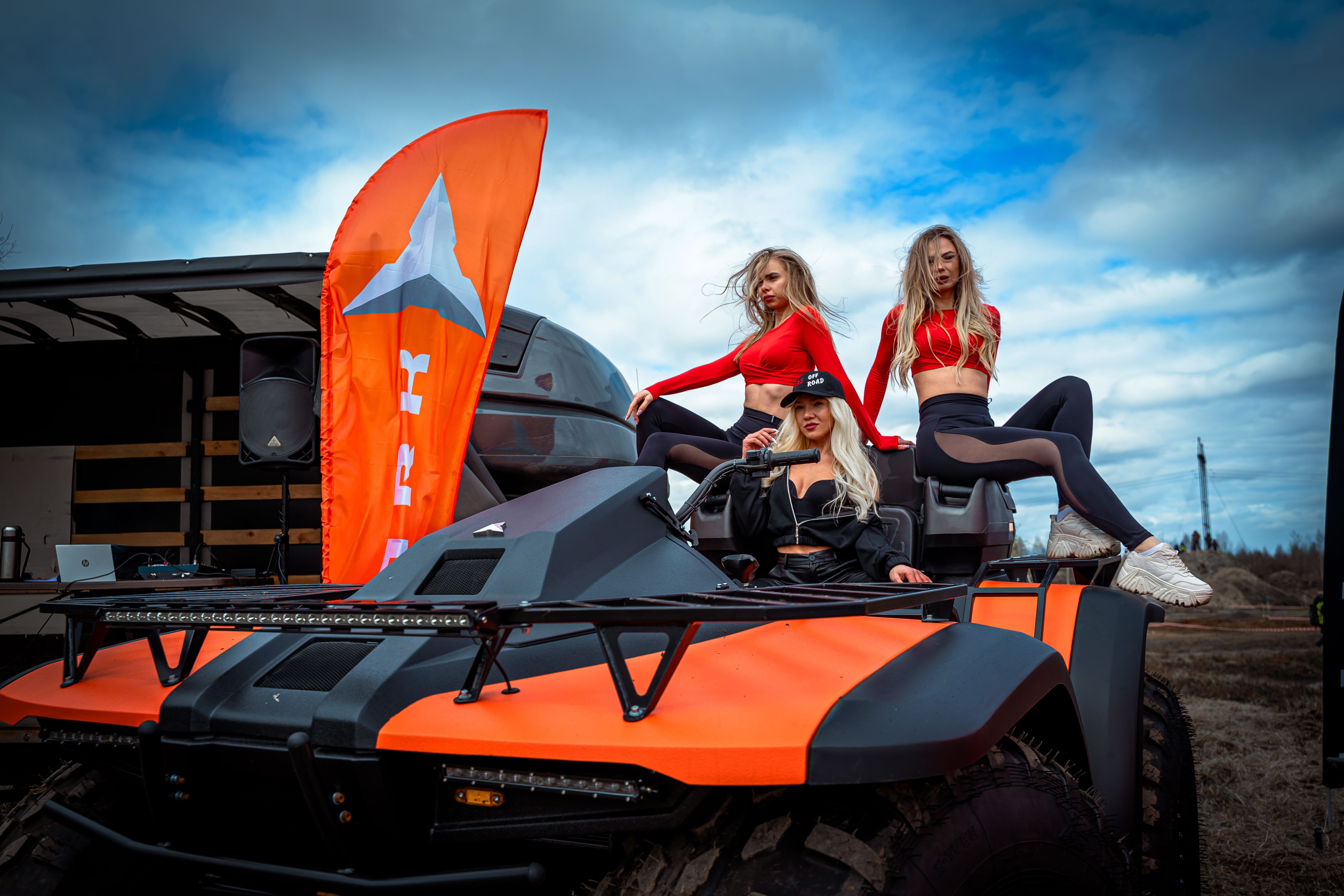 Three women sitting on the back of an atv · Free Stock Photo
