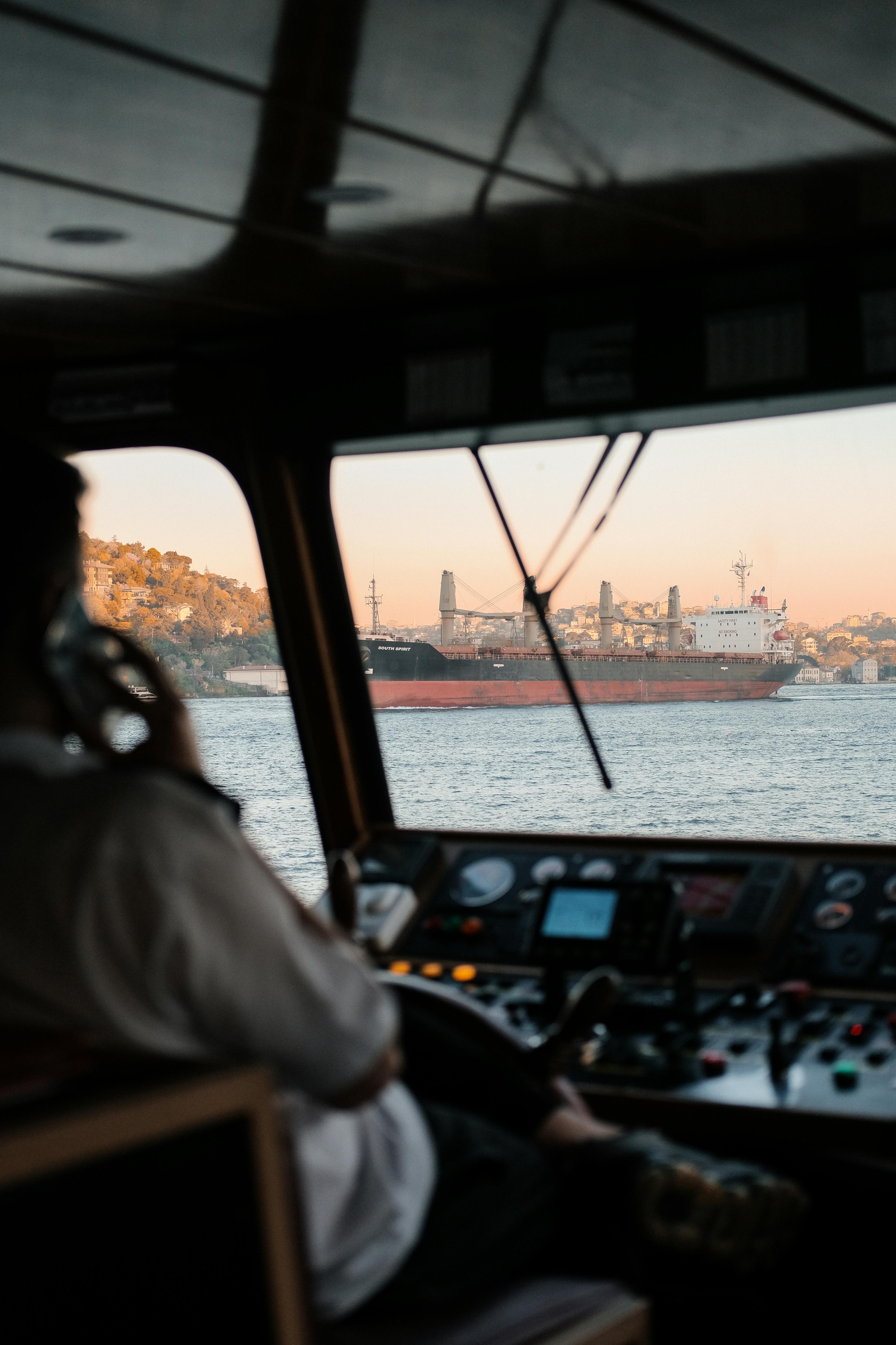 Captain of Ferry Talking on Smartphone · Free Stock Photo