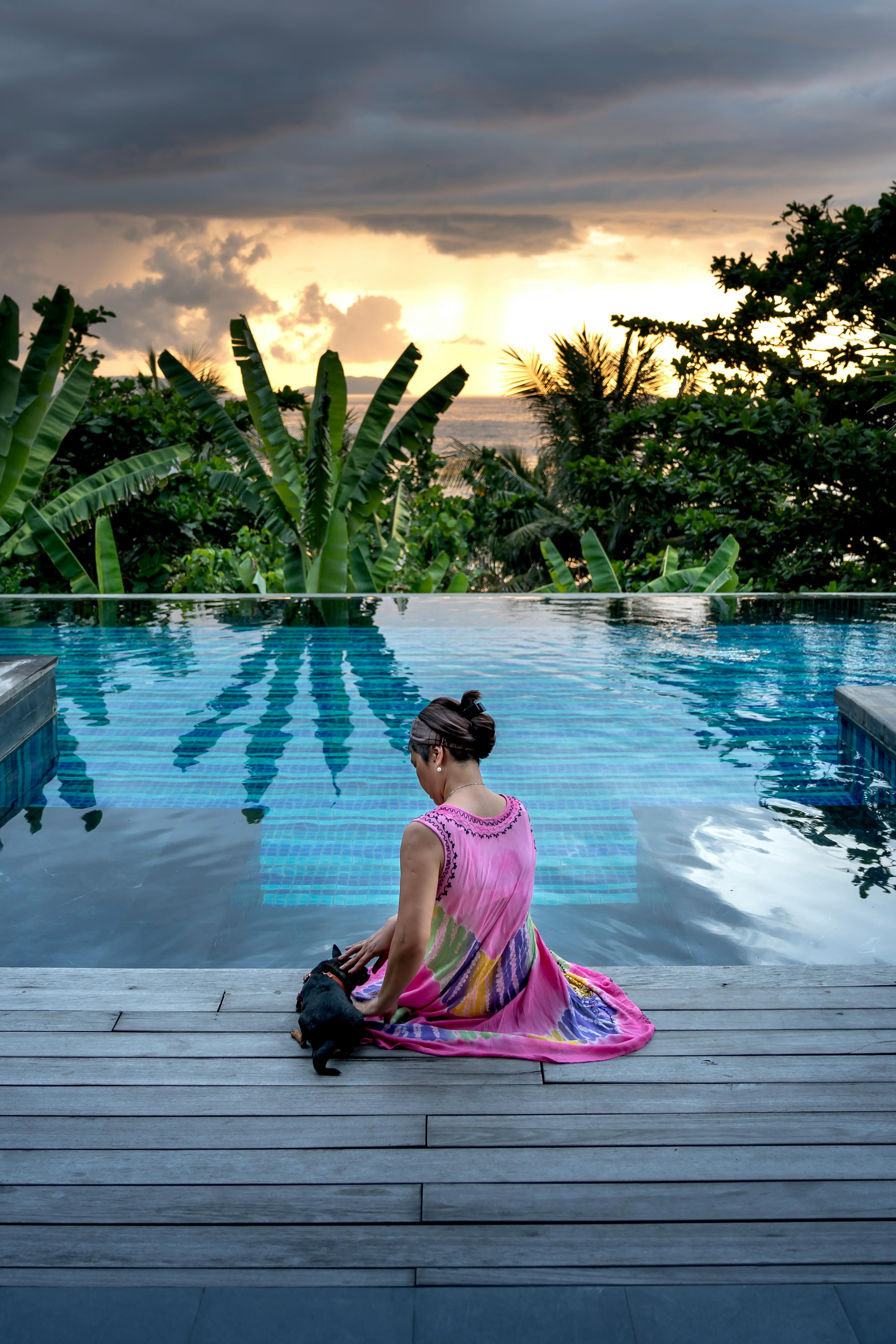 Woman Sitting Facing Pool · Free Stock Photo
