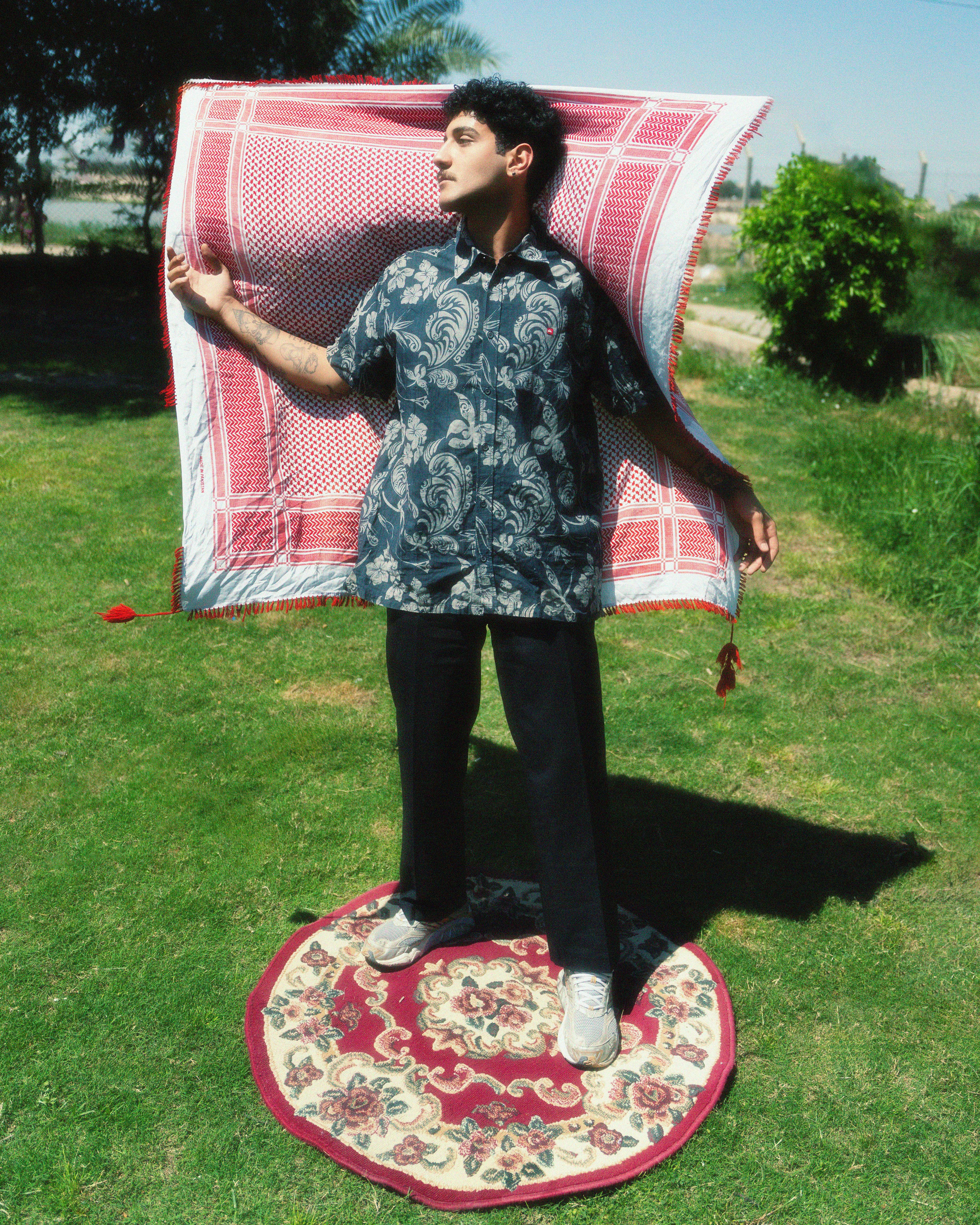 Man Standing on Rug on a Meadow · Free Stock Photo