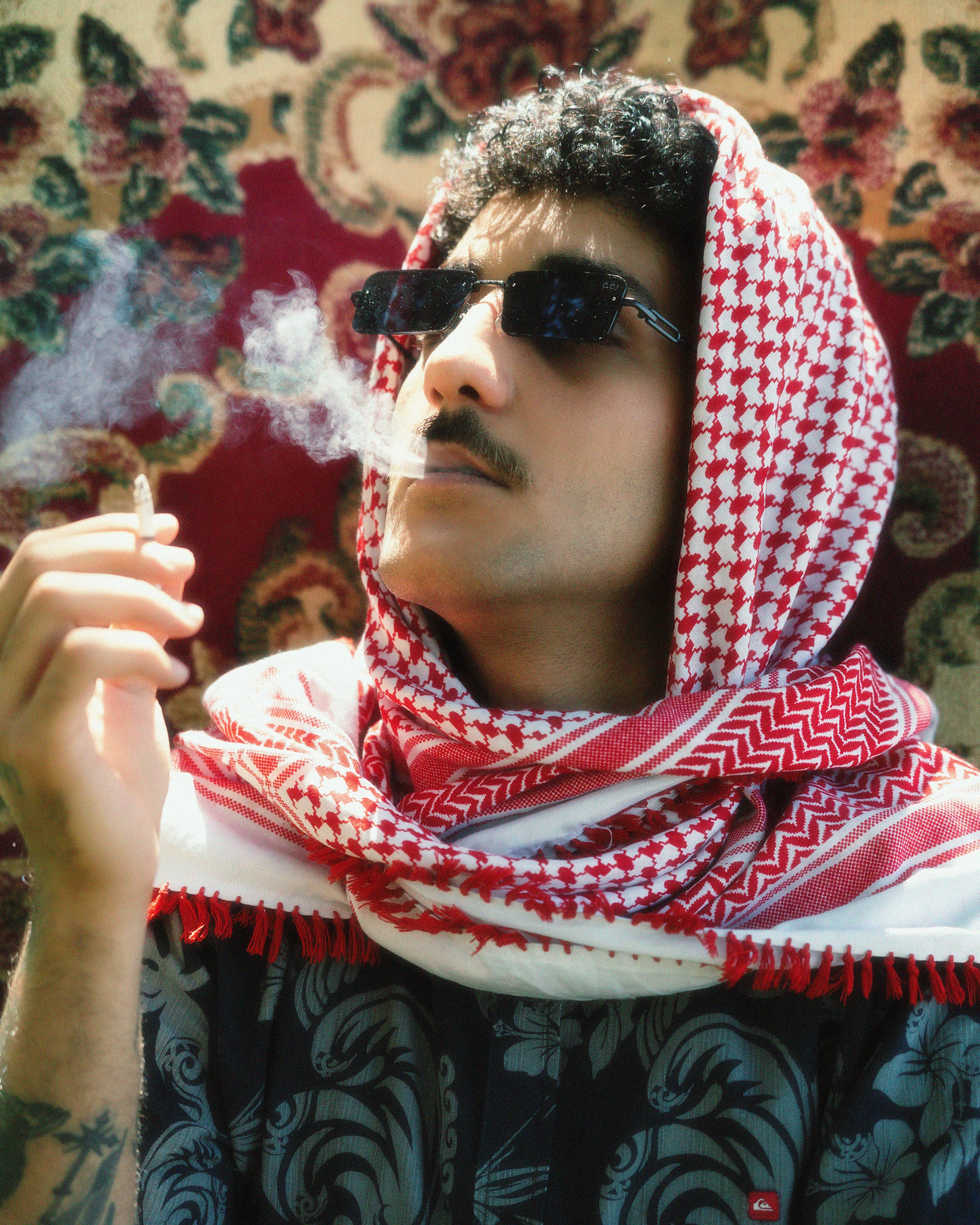 Man in Shawl Smoking Cigarette · Free Stock Photo