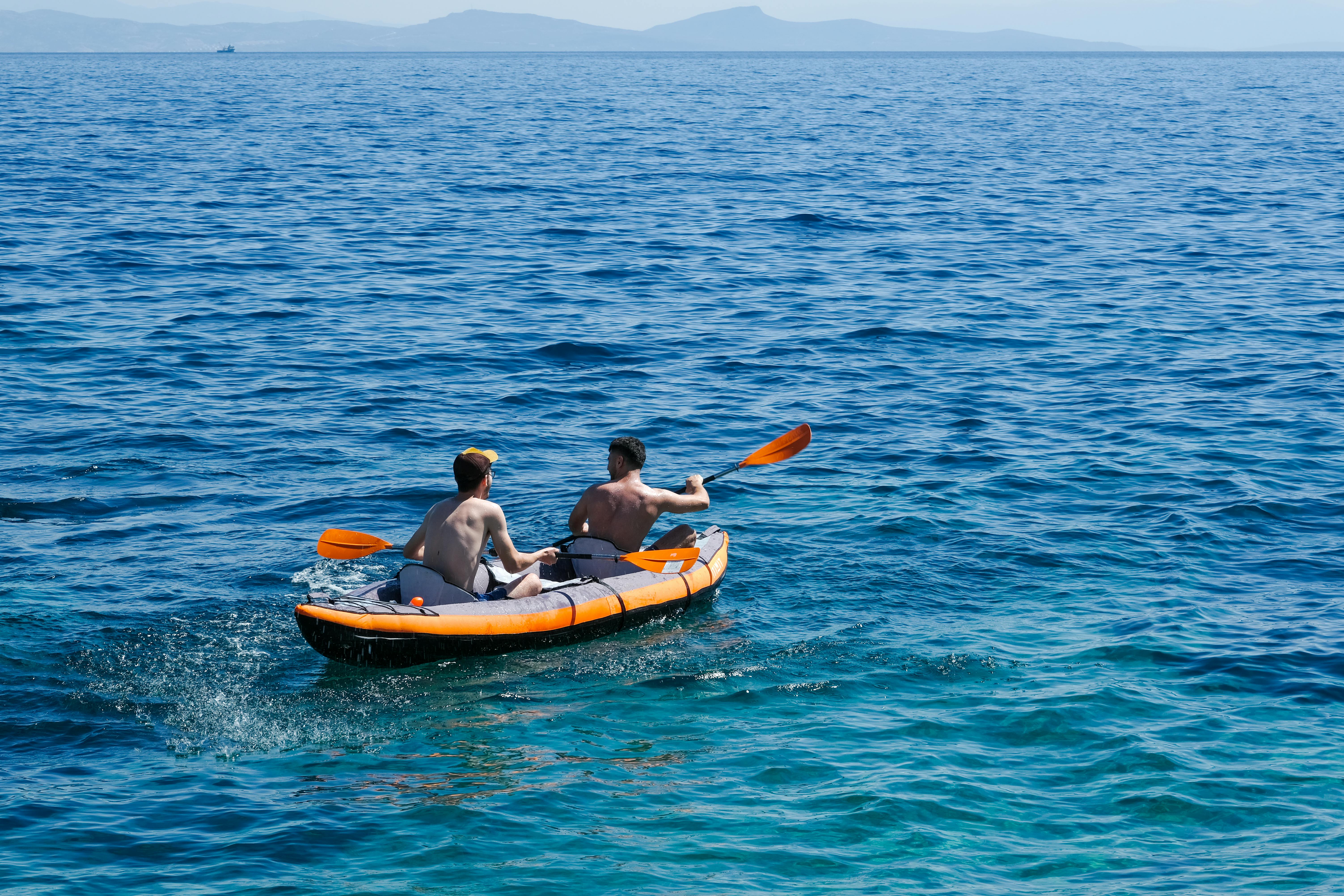 Kayaking Duo on the Open Blue Sea · Free Stock Photo