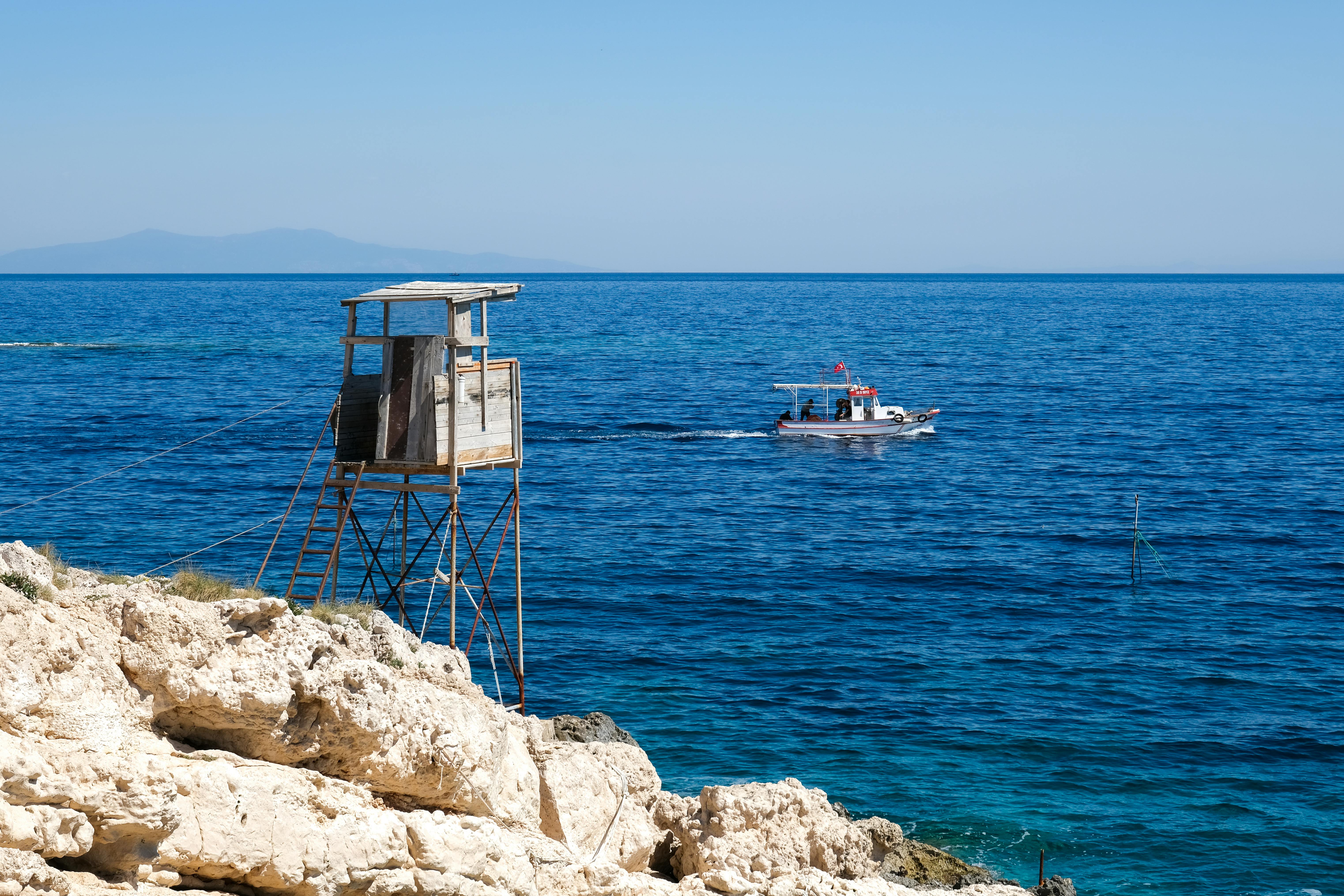 Observation Deck Lookng at a Boat in the Sea · Free Stock Photo