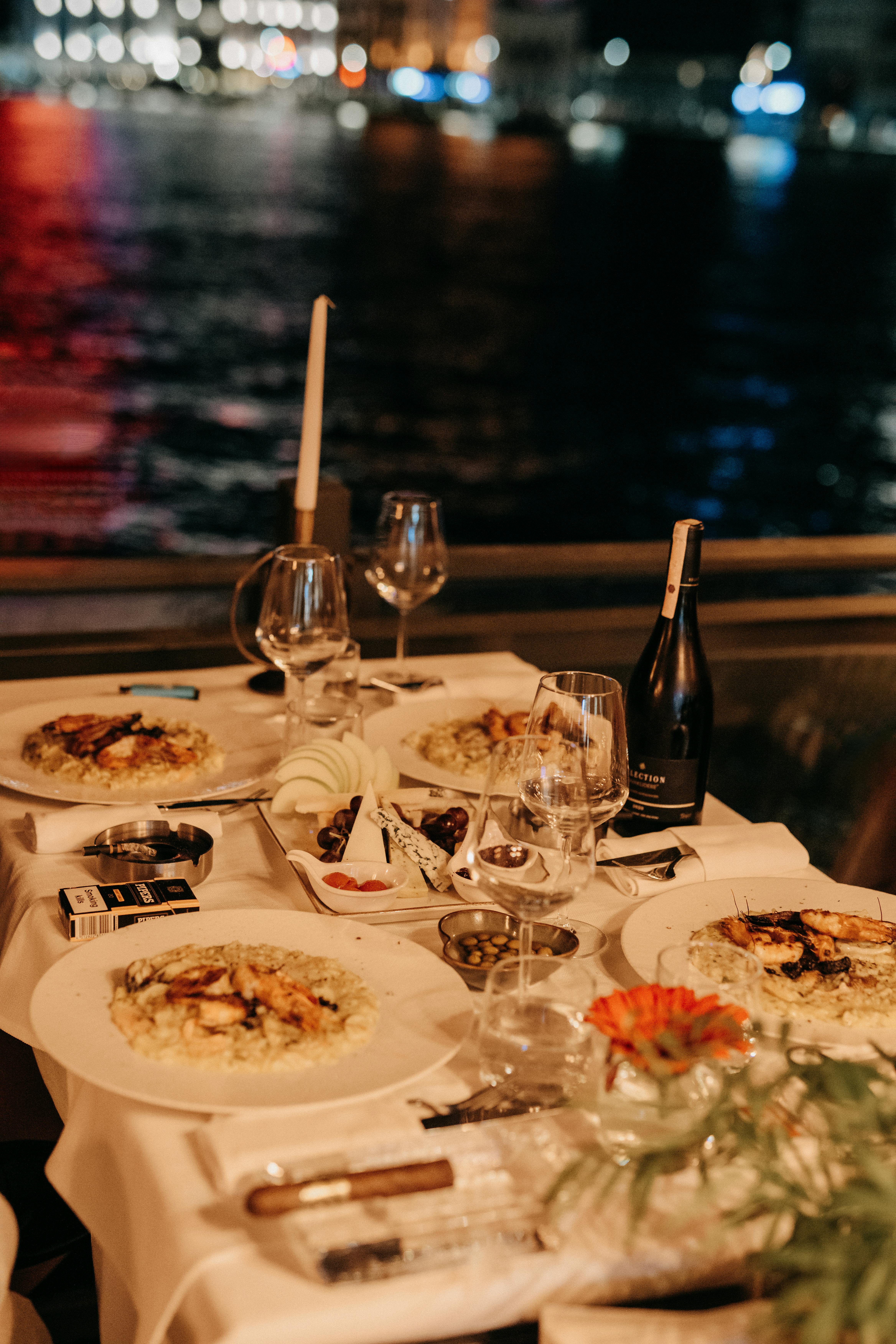 Dinner with Wine on Table by River at Night · Free Stock Photo