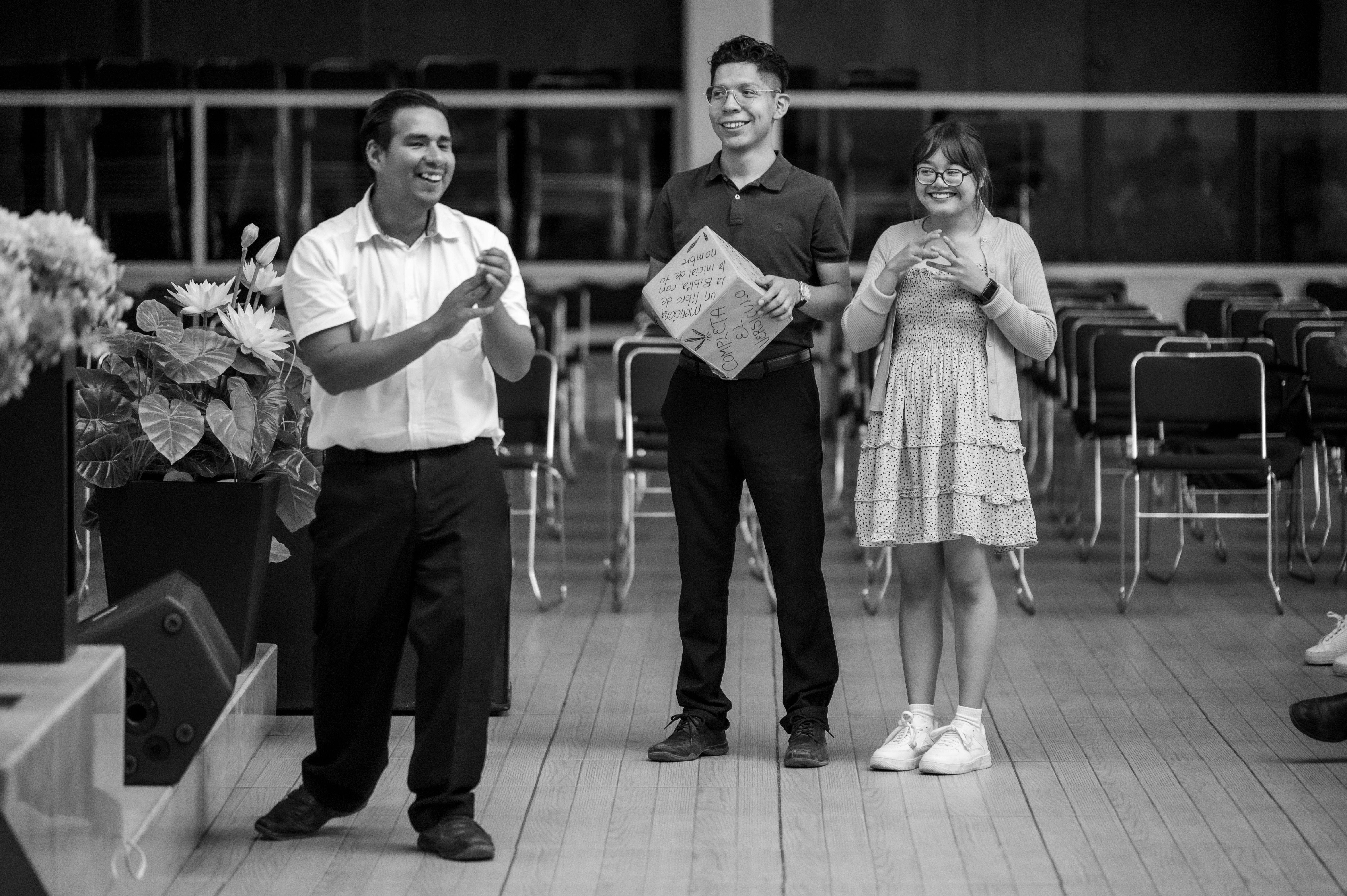 Smiling Woman in Sundress and Men in Black and White · Free Stock Photo