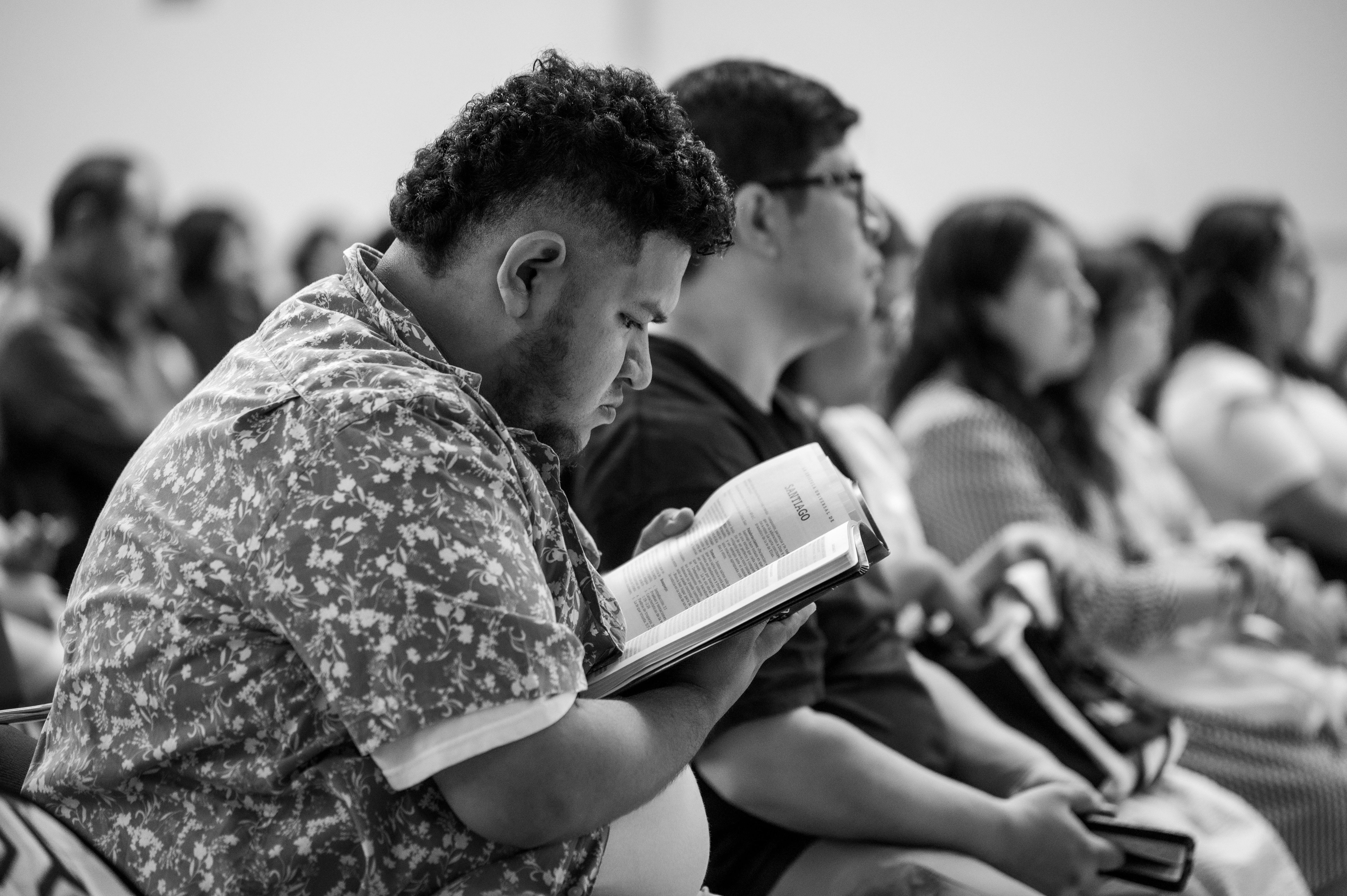 Man Sitting and Reading Bible at House of Worship · Free Stock Photo