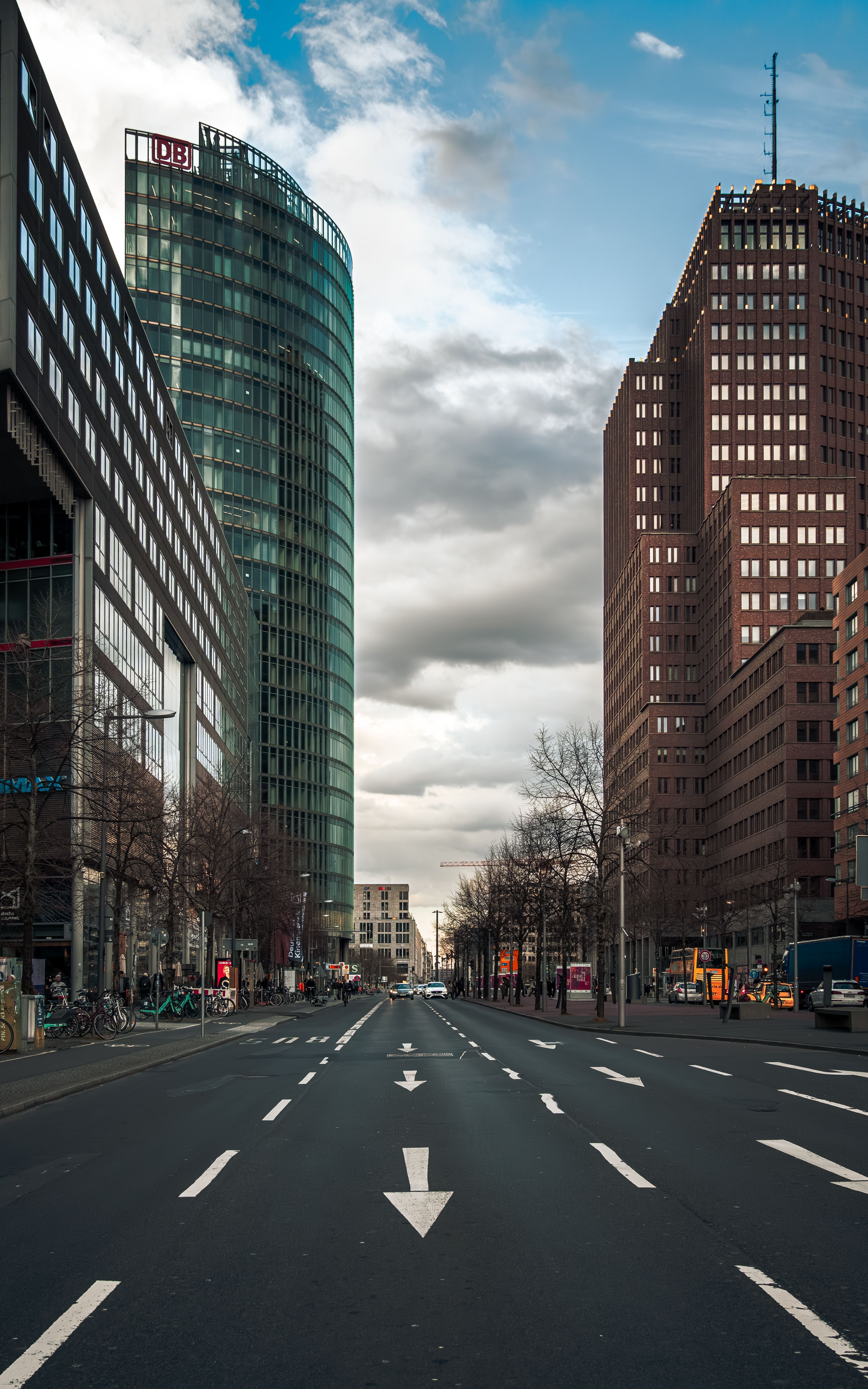 An empty street with tall buildings in the background · Free Stock Photo