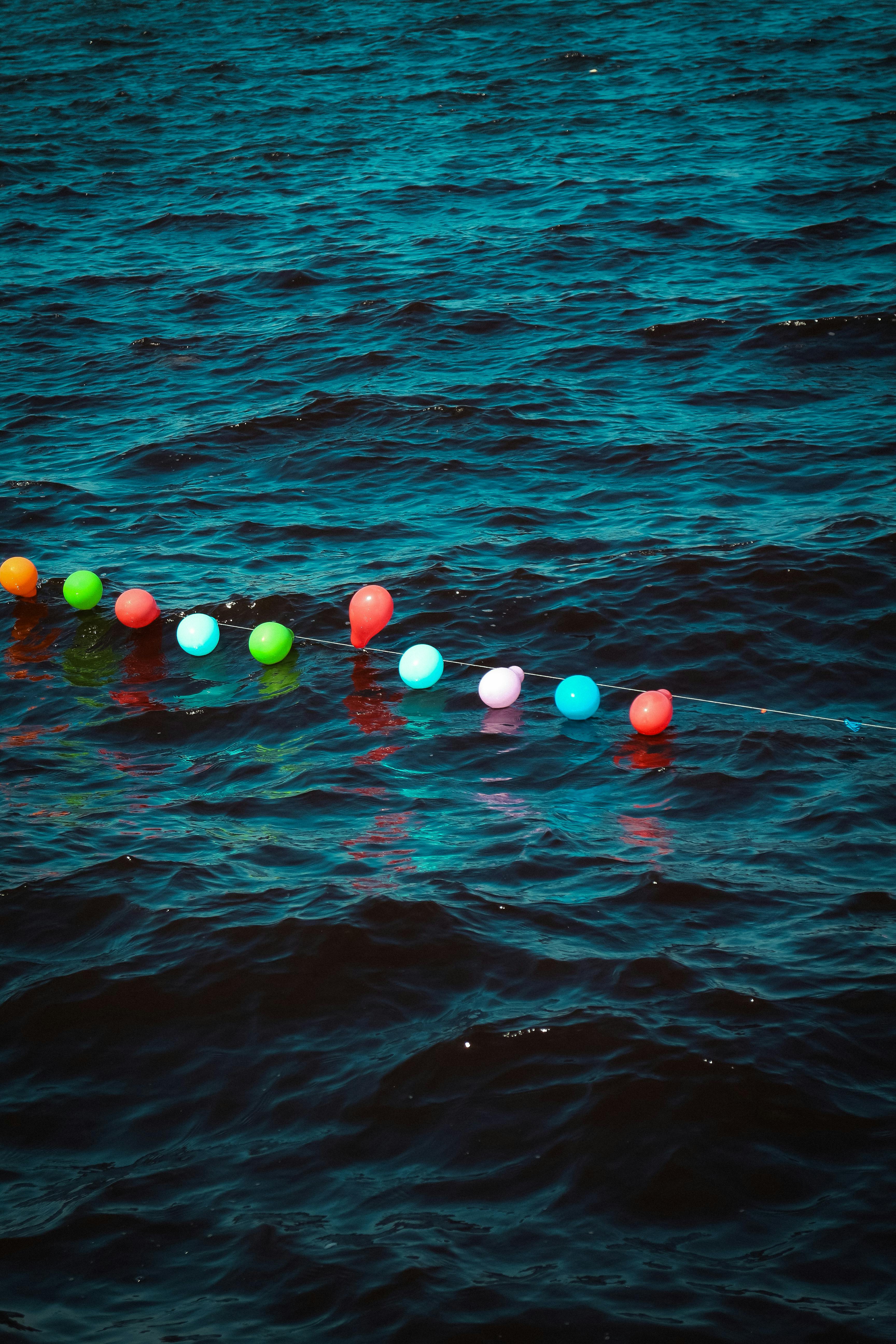 A Colorful Balloons on Body of Water · Free Stock Photo