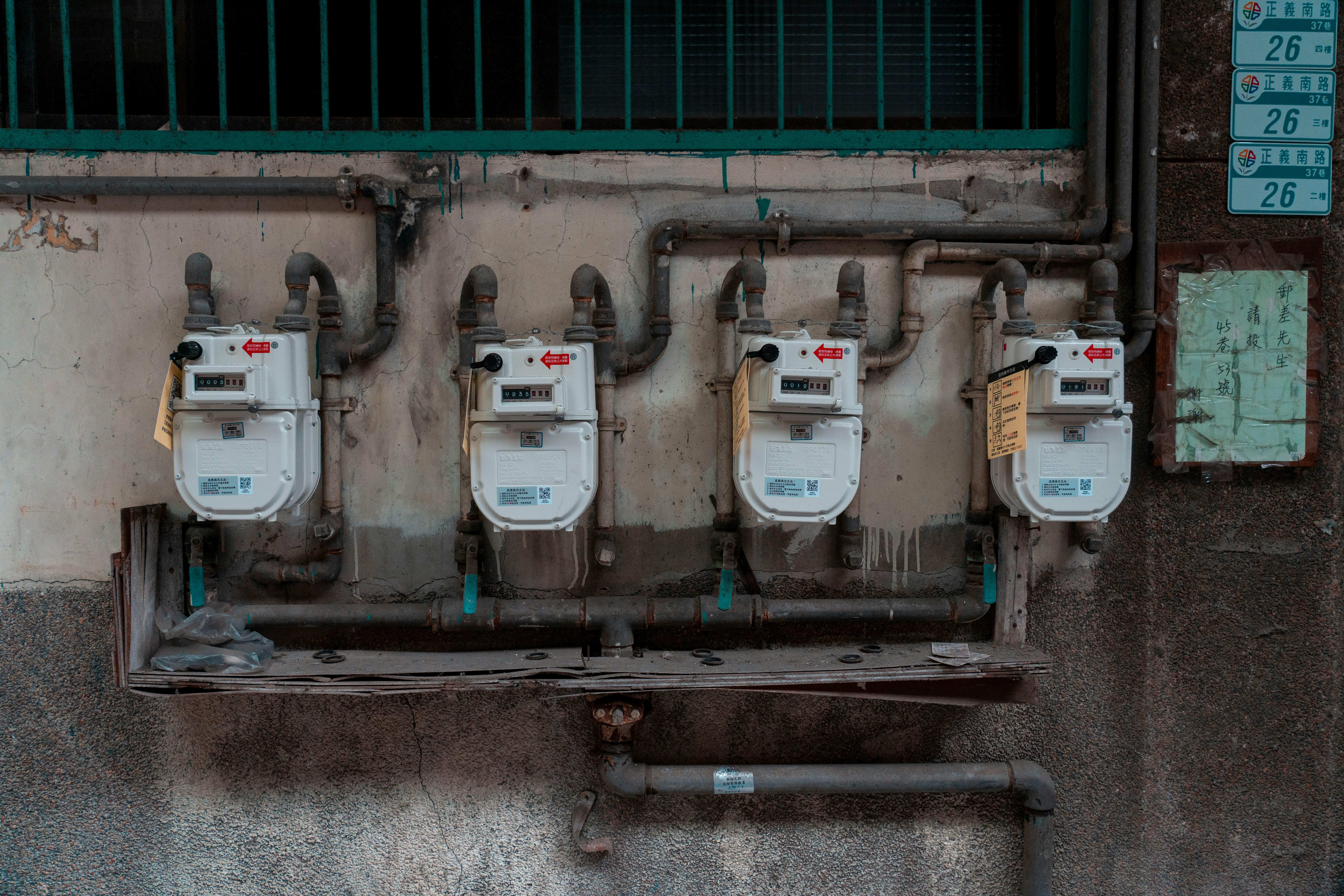 A row of electrical meters on a wall · Free Stock Photo