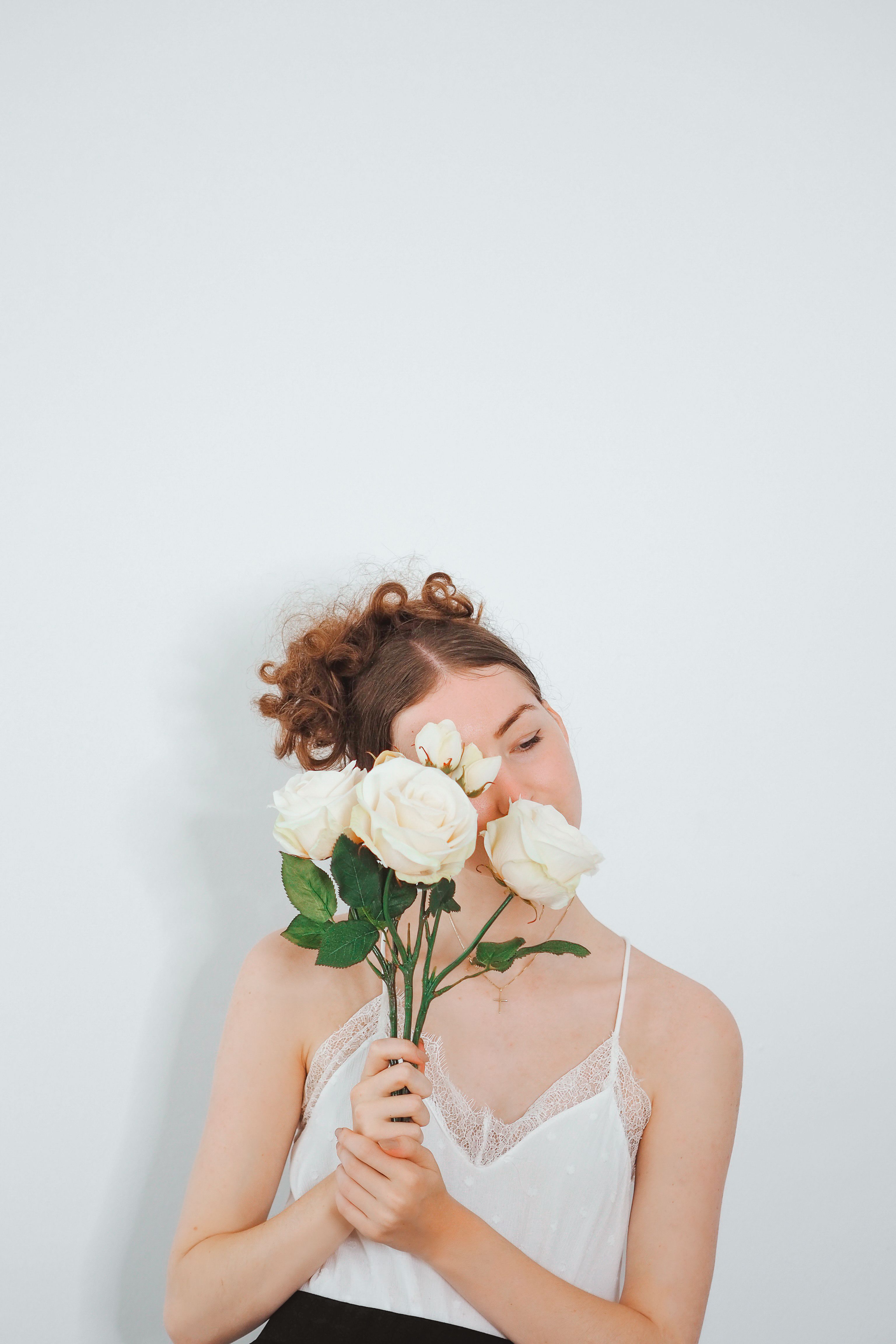 Model in Blouse Posing with Flowers · Free Stock Photo