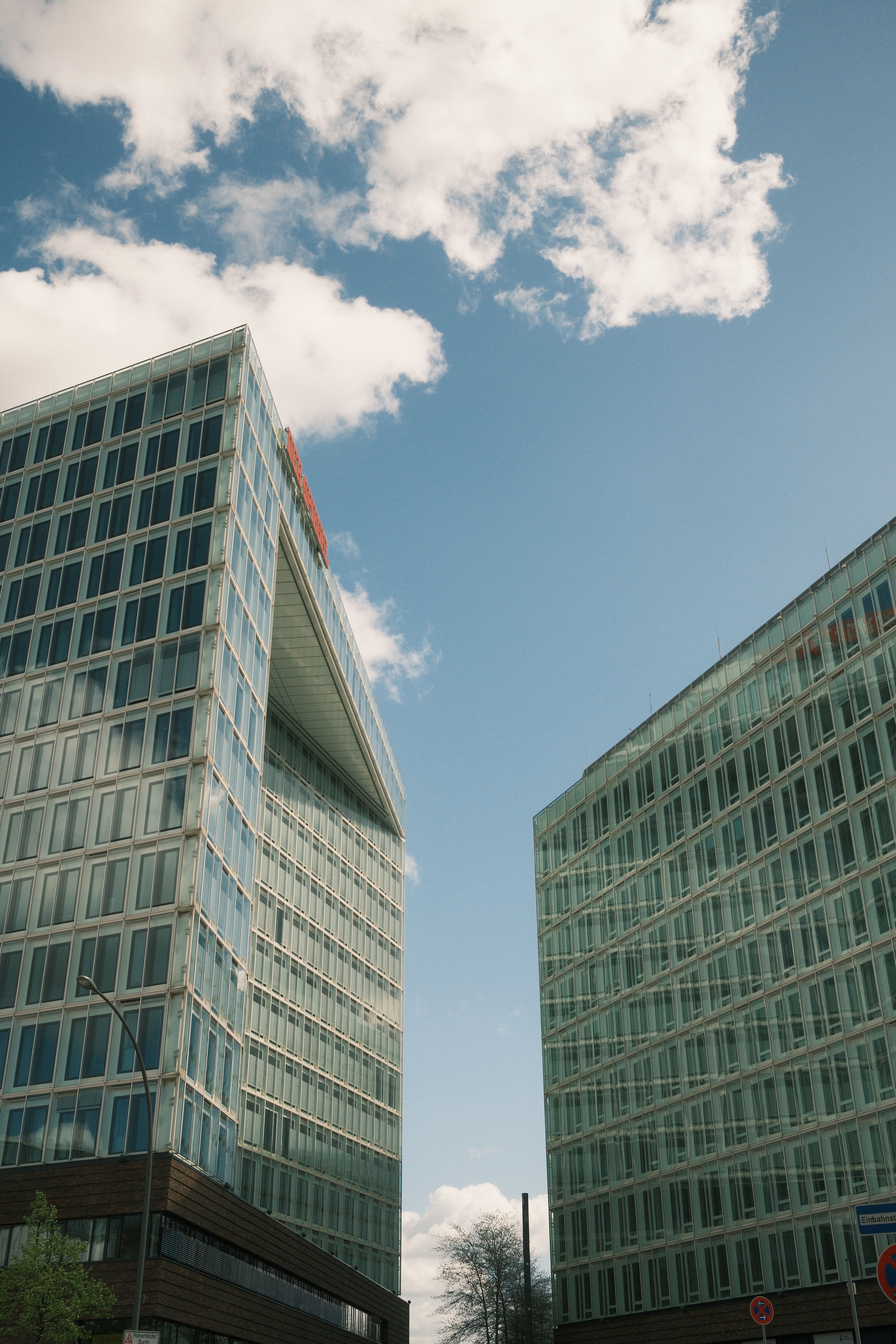 Two tall buildings with windows and a blue sky · Free Stock Photo