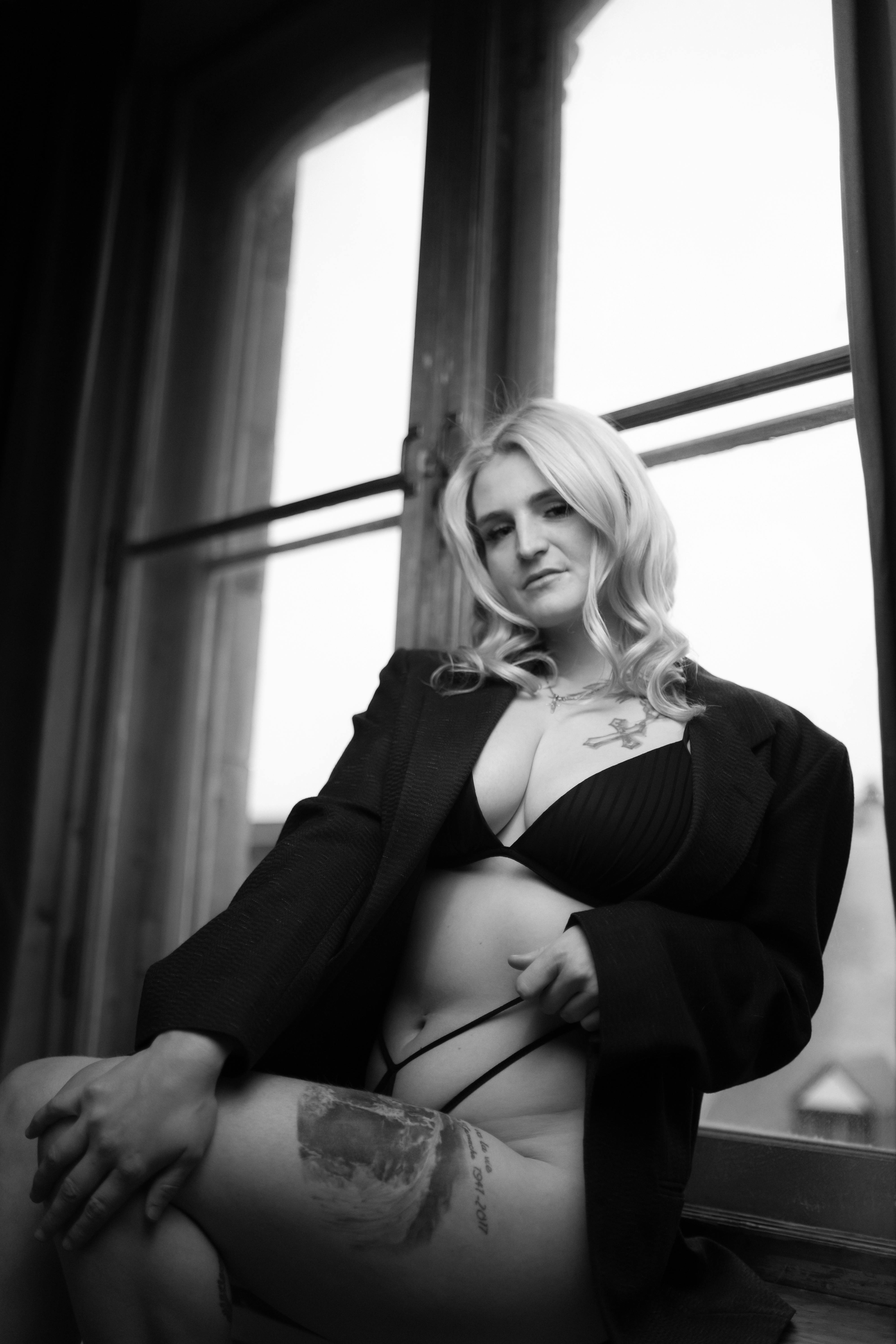 Model in a Blazer and Lingerie Posing in the Window · Free Stock Photo