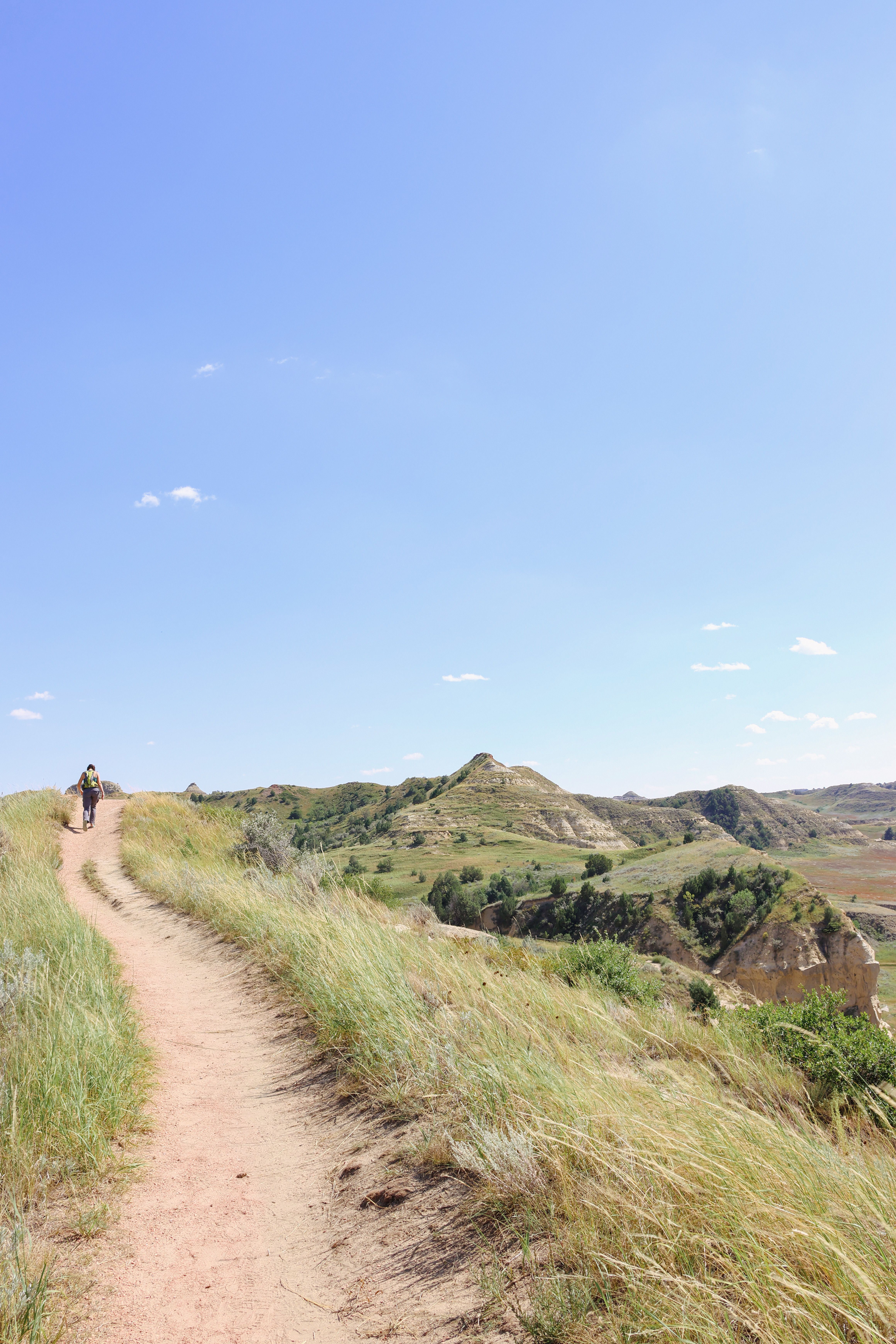 A Person Hiking on a Trail in the Distance · Free Stock Photo