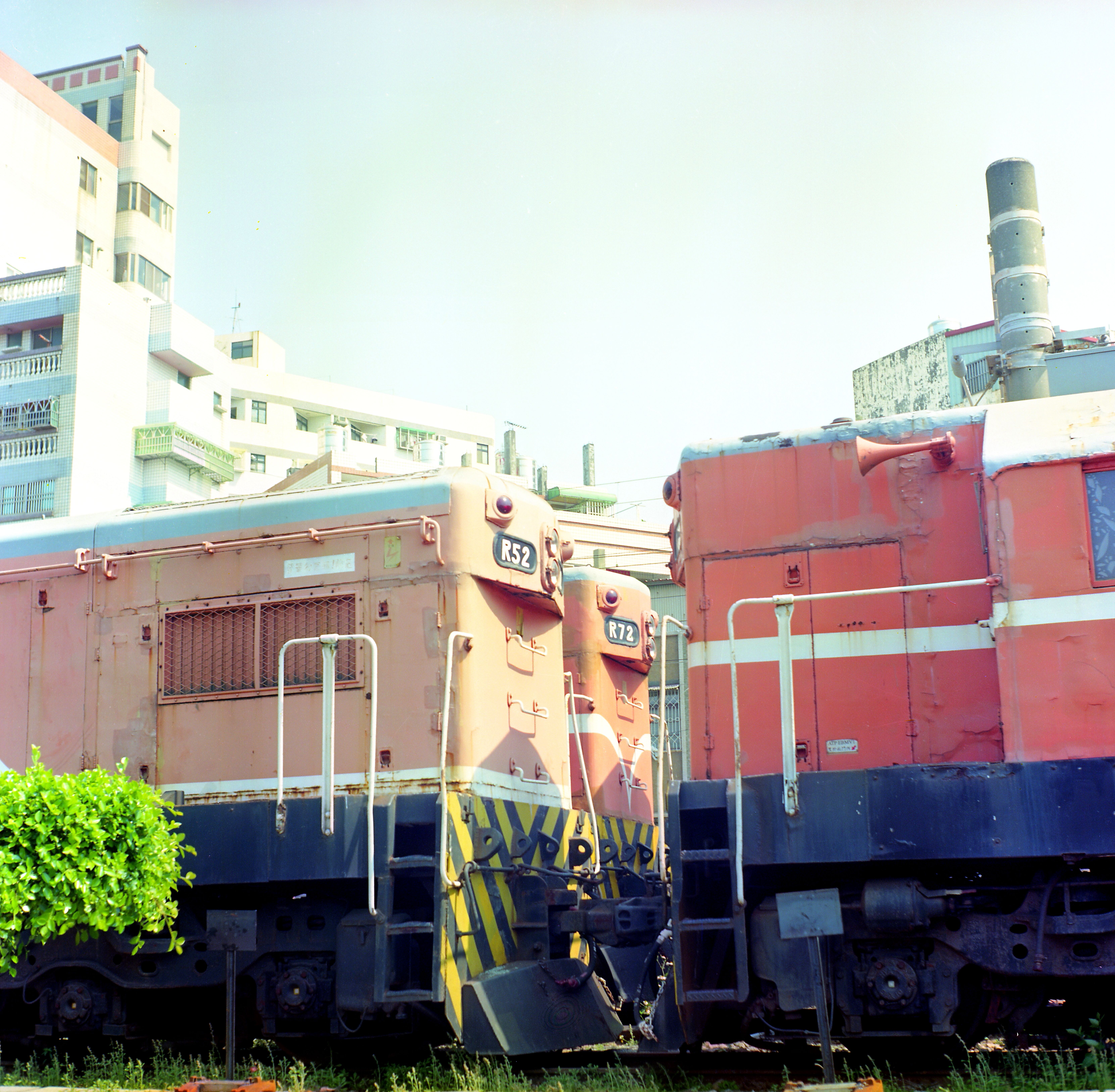 Vintage Locomotives near Buildings · Free Stock Photo