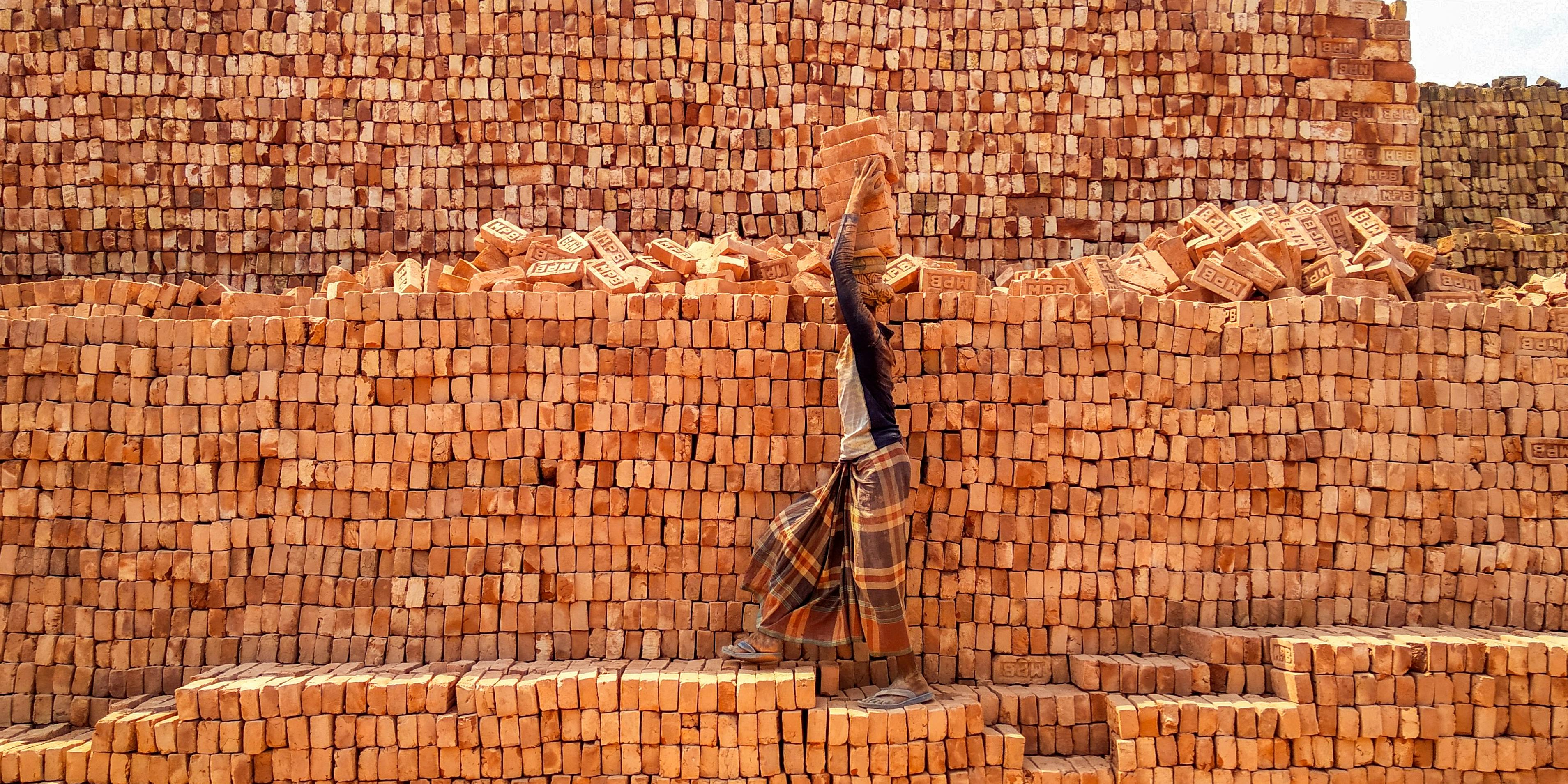 Man Carrying Bricks at Construction · Free Stock Photo
