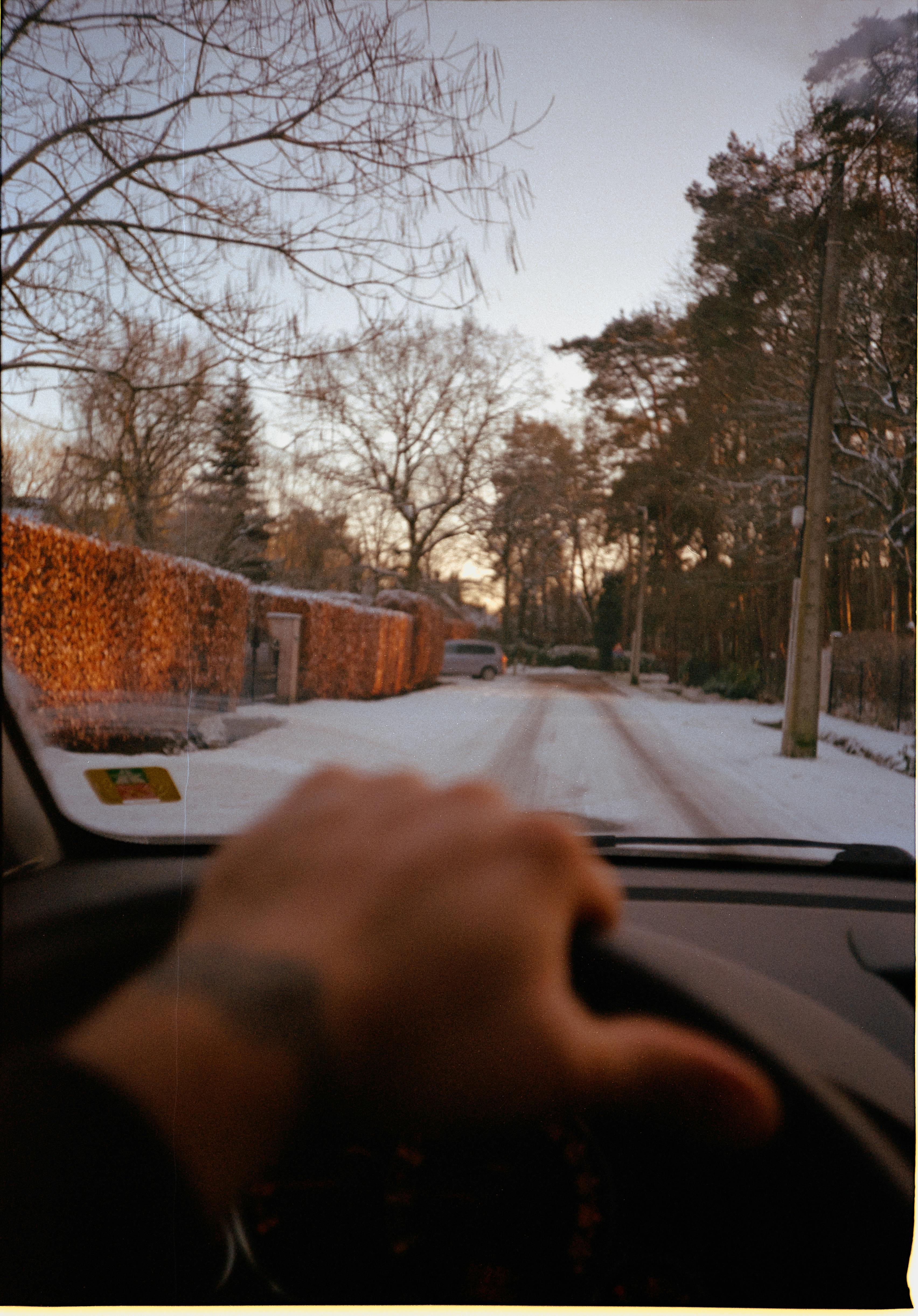 Slippery Road in Front of Driver with Hand on Steering Wheel · Free ...