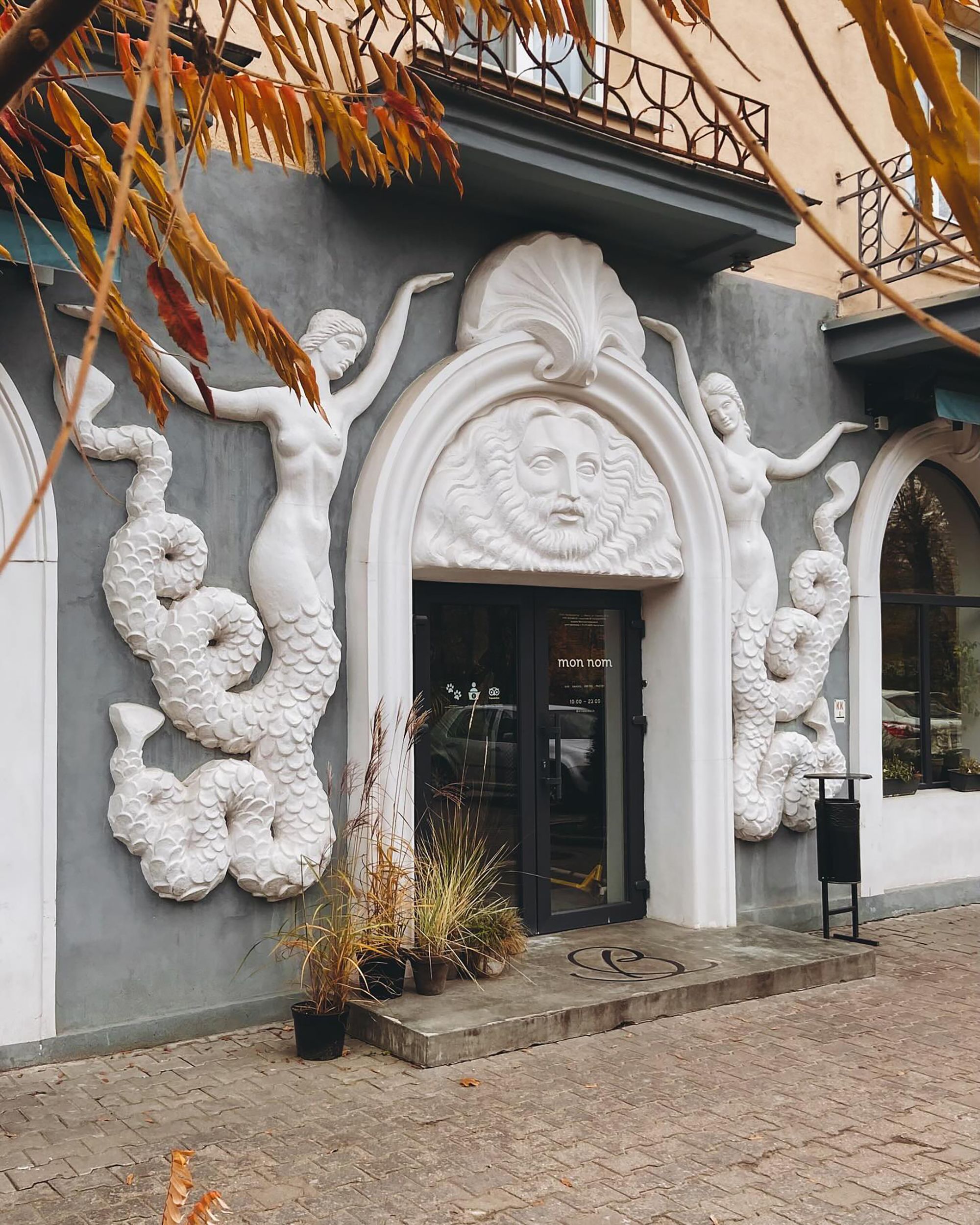 Sirens Sculptures around Building Entrance · Free Stock Photo