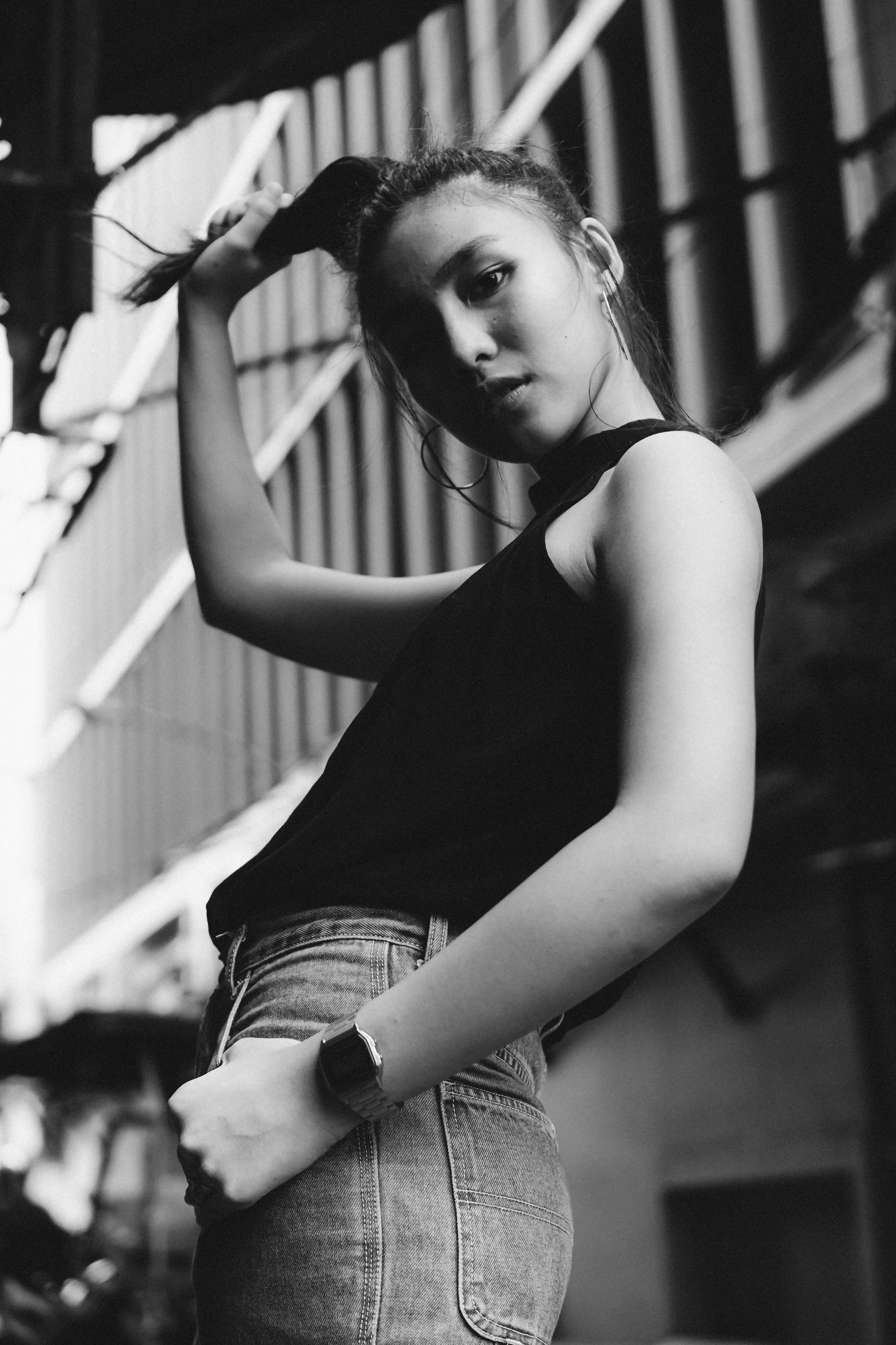 Portrait of a Pretty Brunette Tousling her Hair · Free Stock Photo