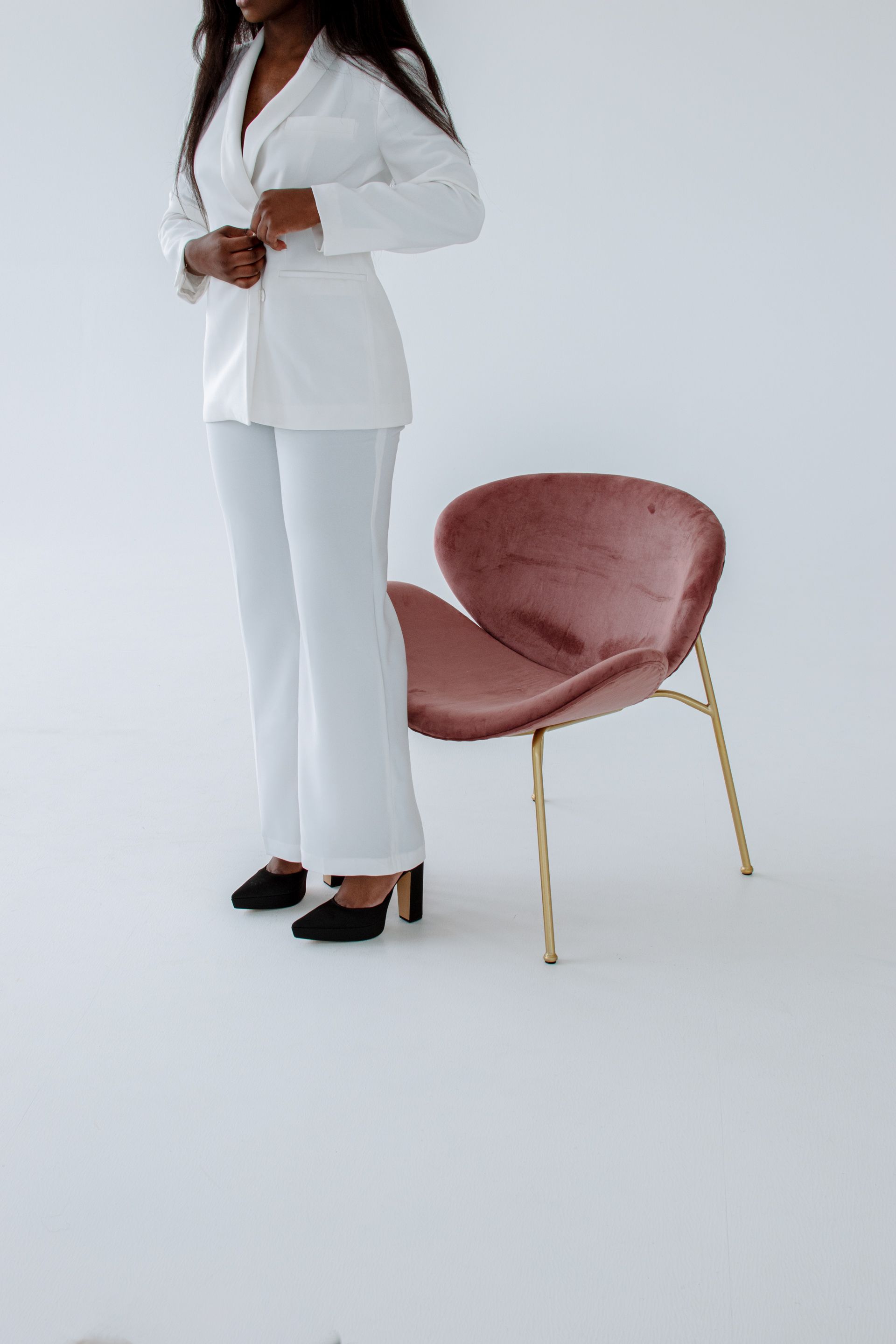 Studio Shot of a Female Model Standing in Front of a Chair · Free Stock ...