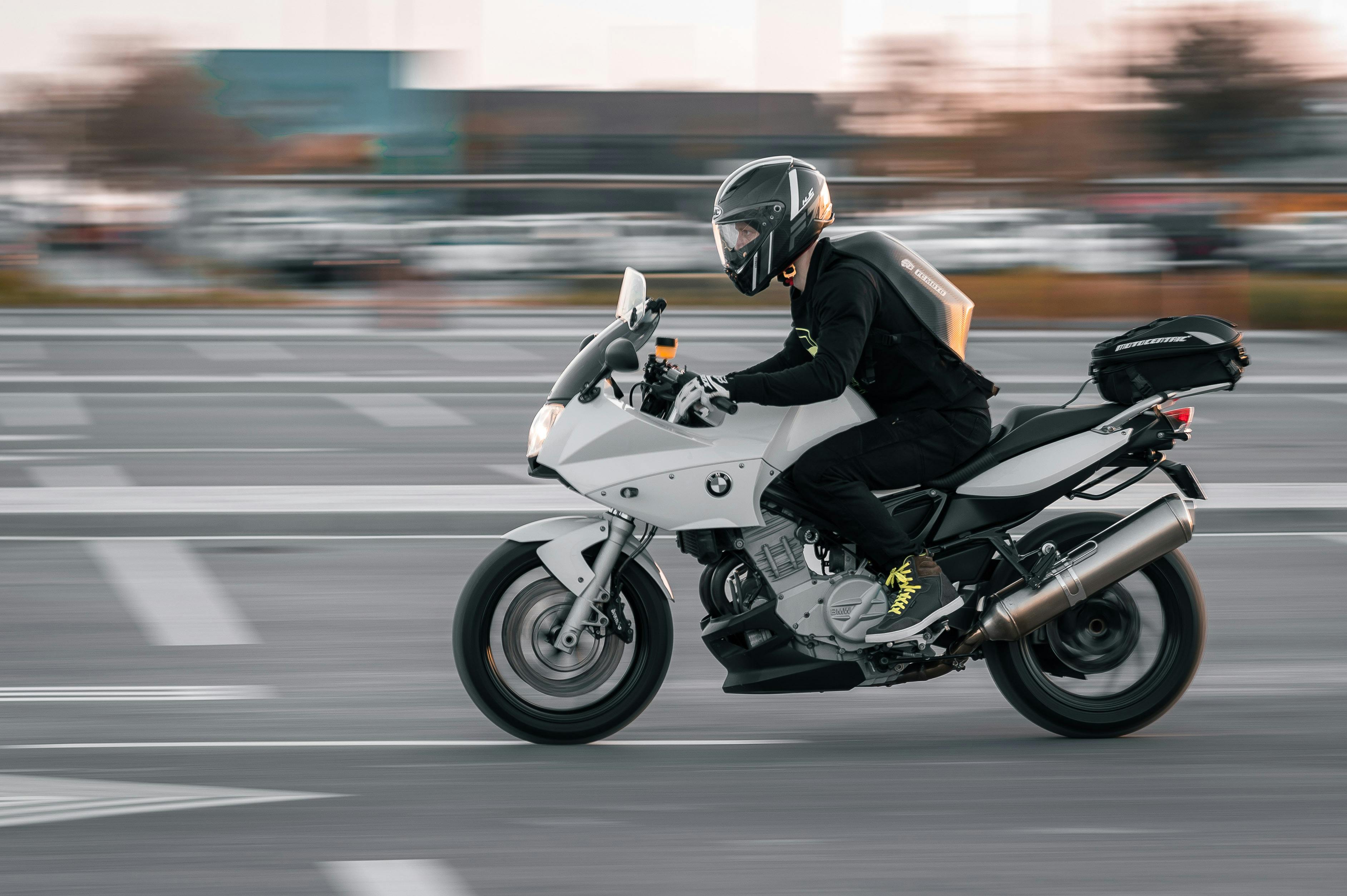 Motorcyclist Riding BMW F 800 on Asphalt · Free Stock Photo