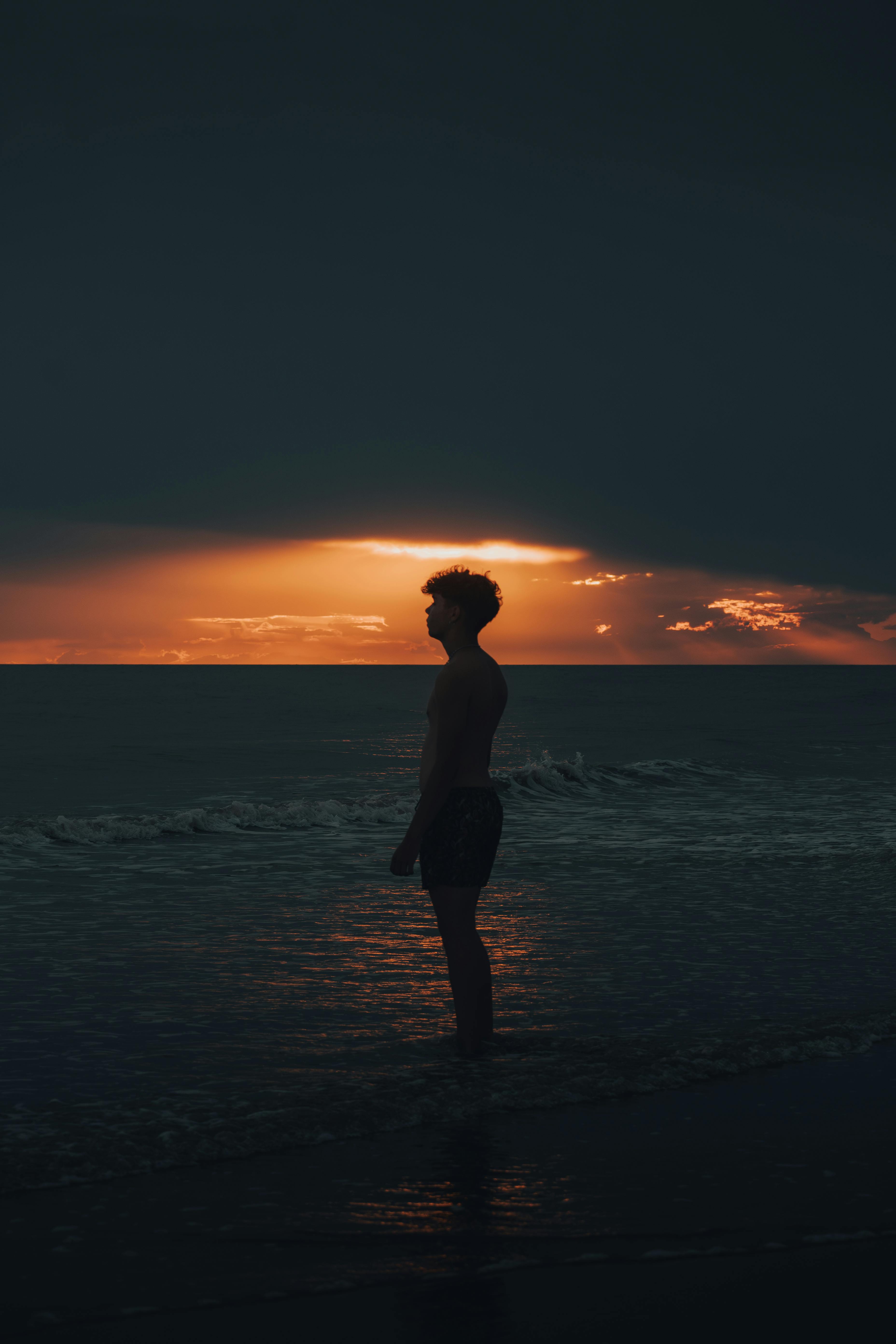 Man in Sea at Sunset · Free Stock Photo