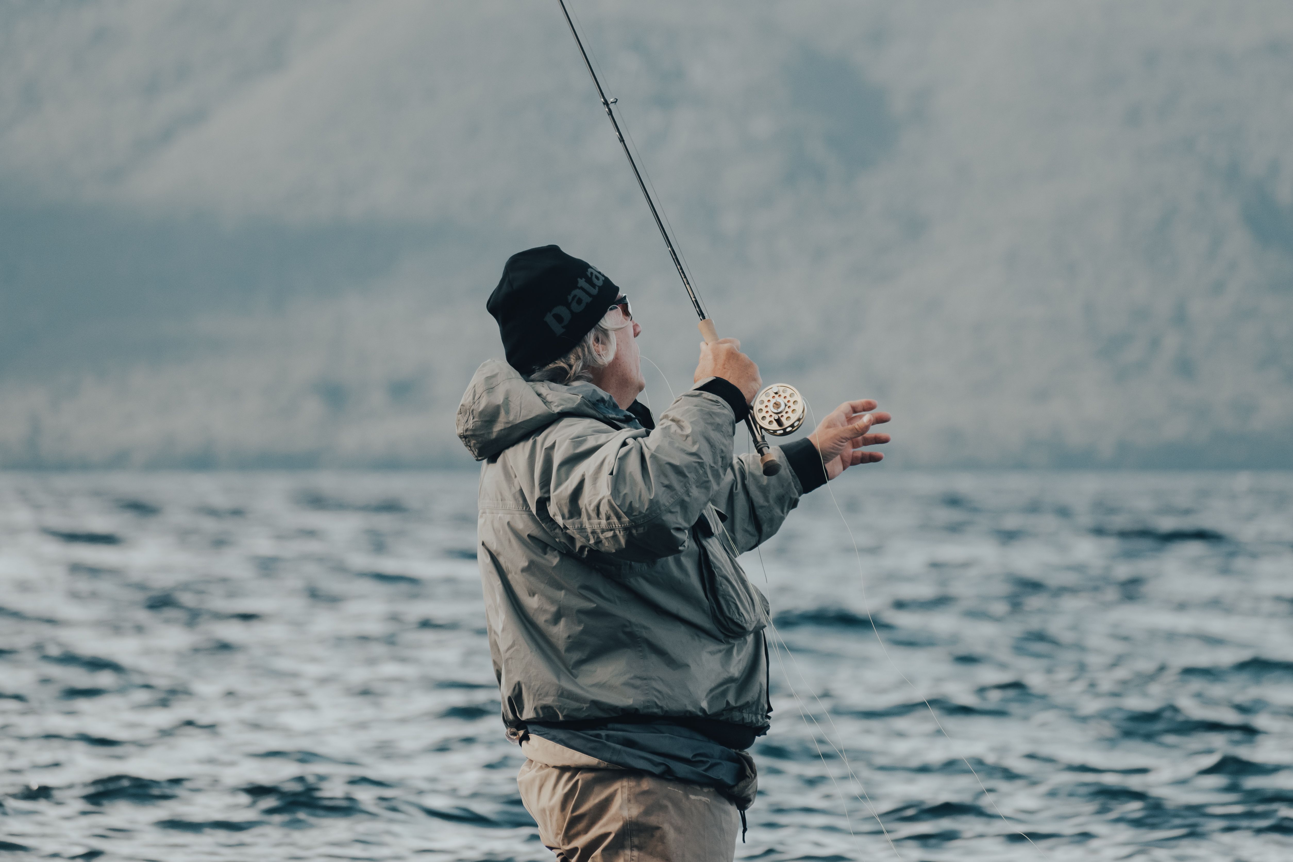 Angler Wearing Jacket and Hat · Free Stock Photo