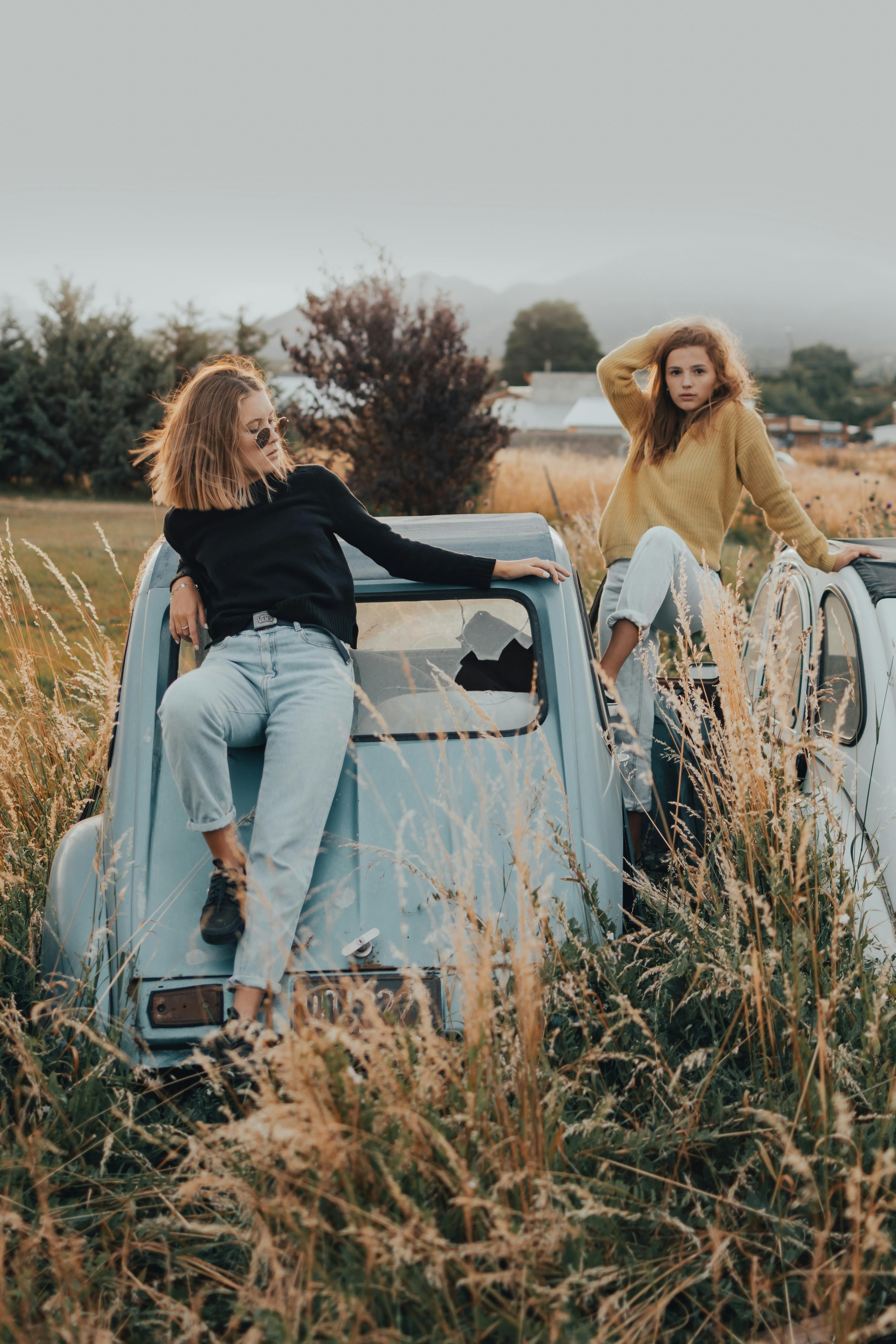 Casual Style Models Posing with Vintage Cars · Free Stock Photo