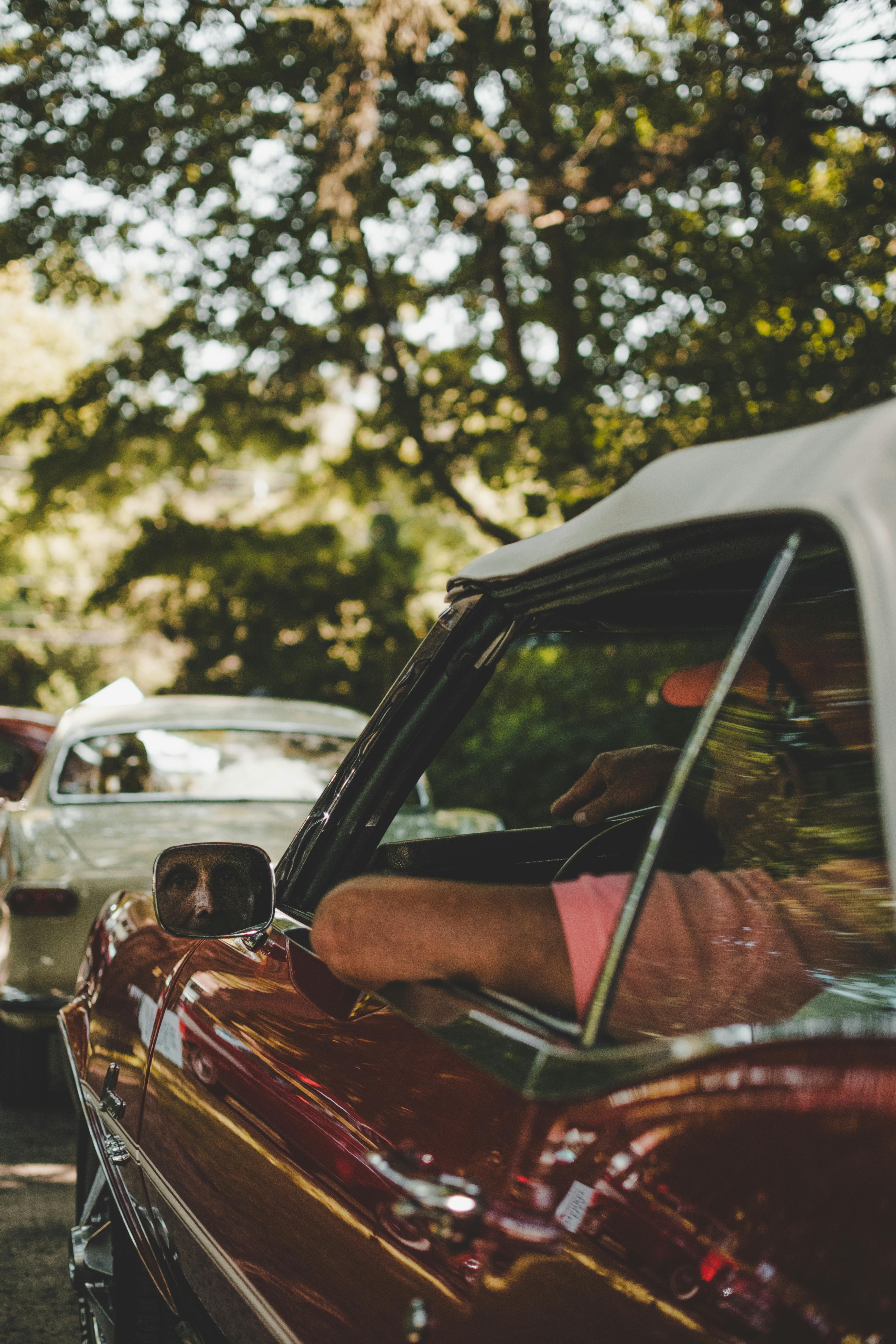Elbow of Driver on Door of Red Classic Car · Free Stock Photo