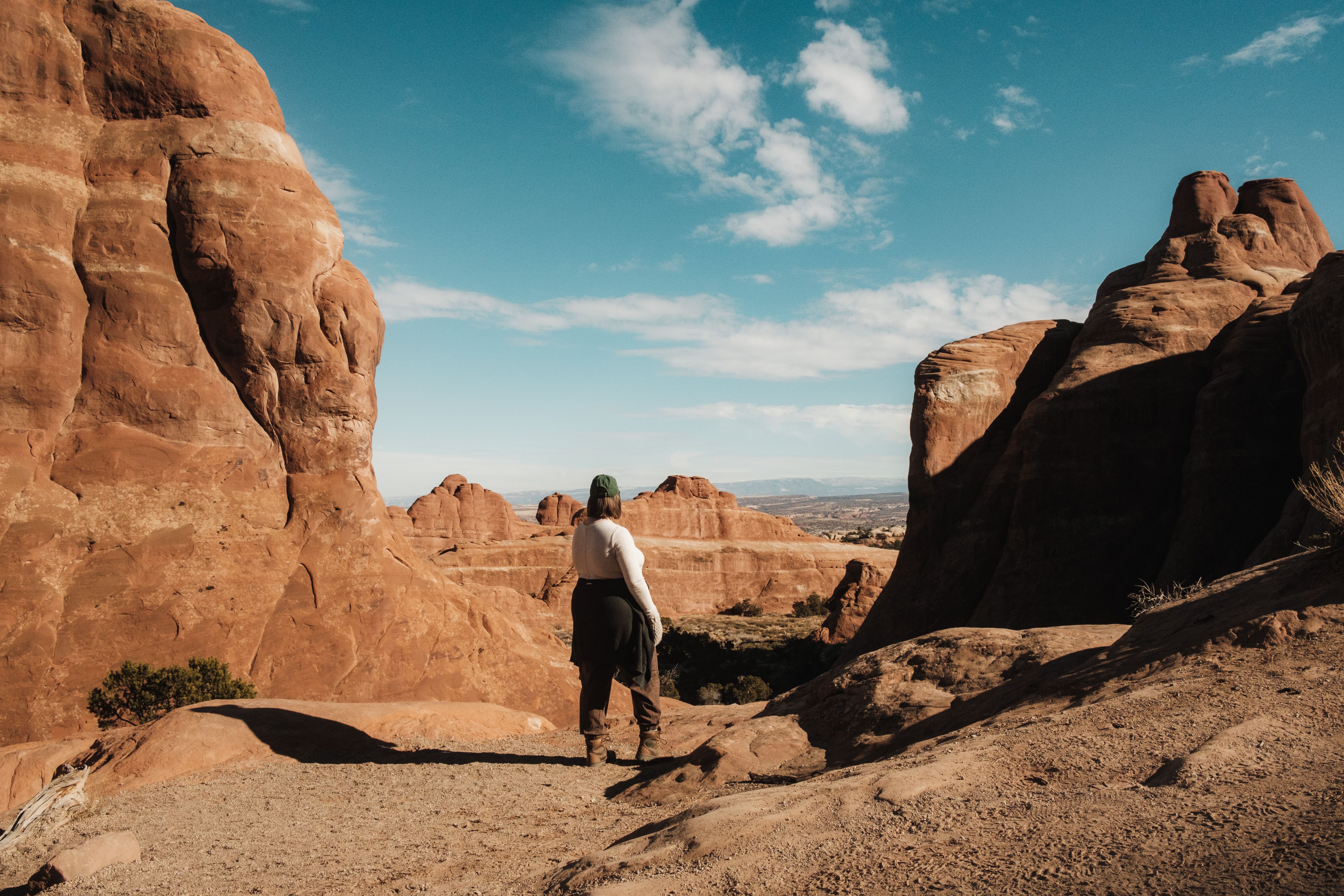A person walking through a desert landscape · Free Stock Photo