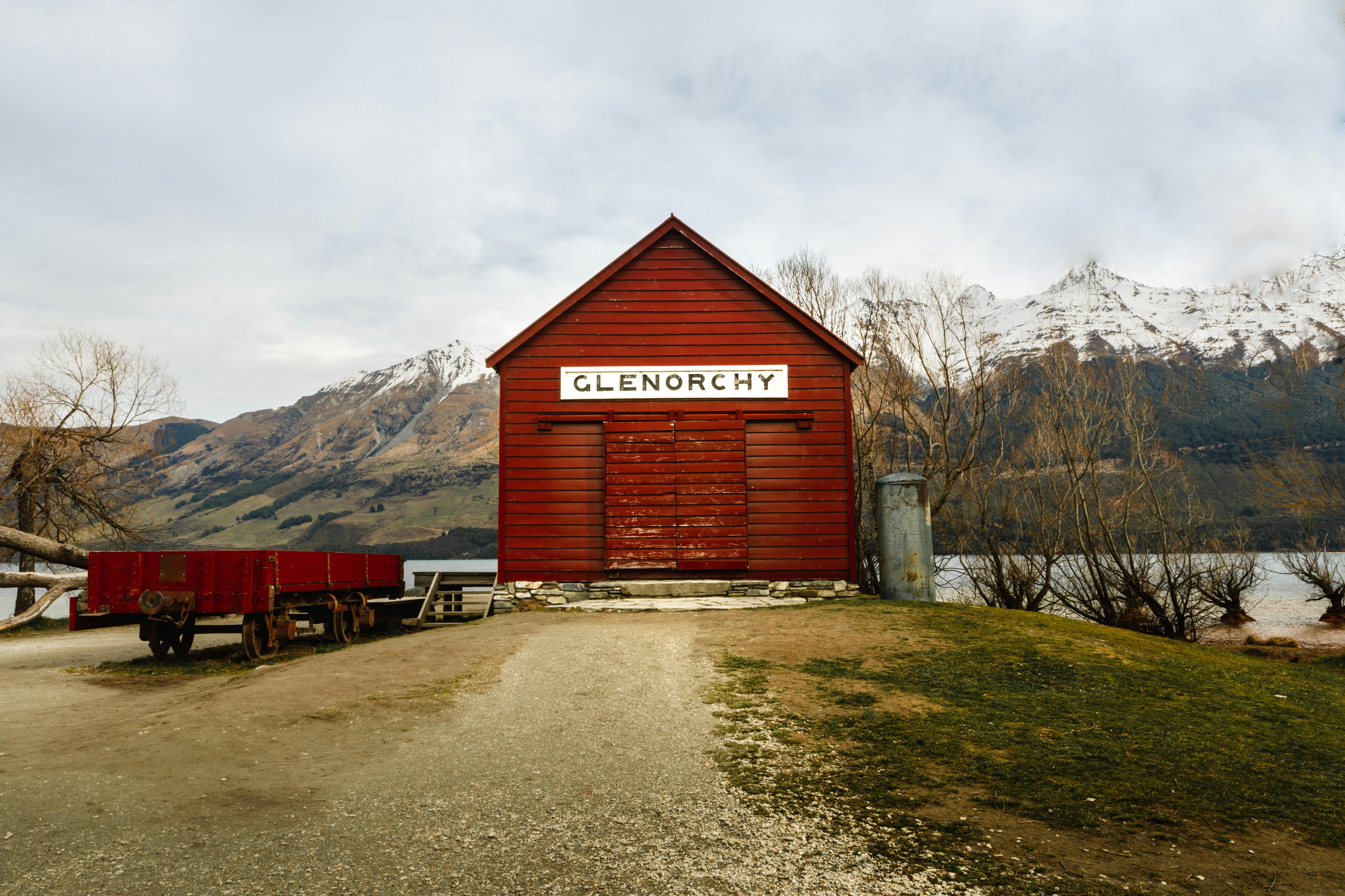 Red Shed Near Body Of Water · Free Stock Photo