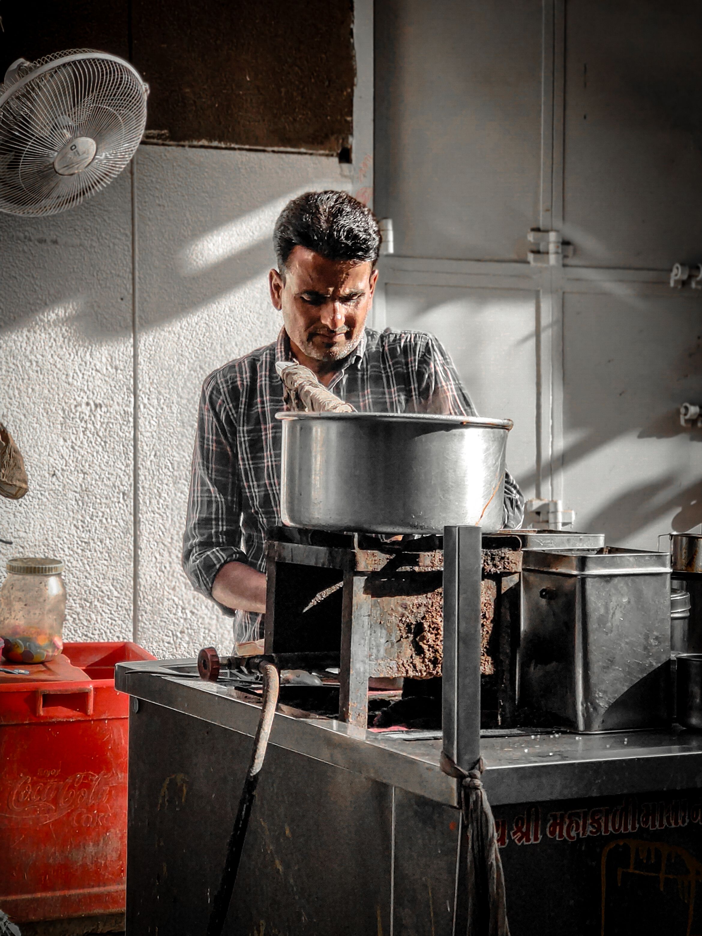 Photo of a Man Cooking Using a Large Metal Pot · Free Stock Photo
