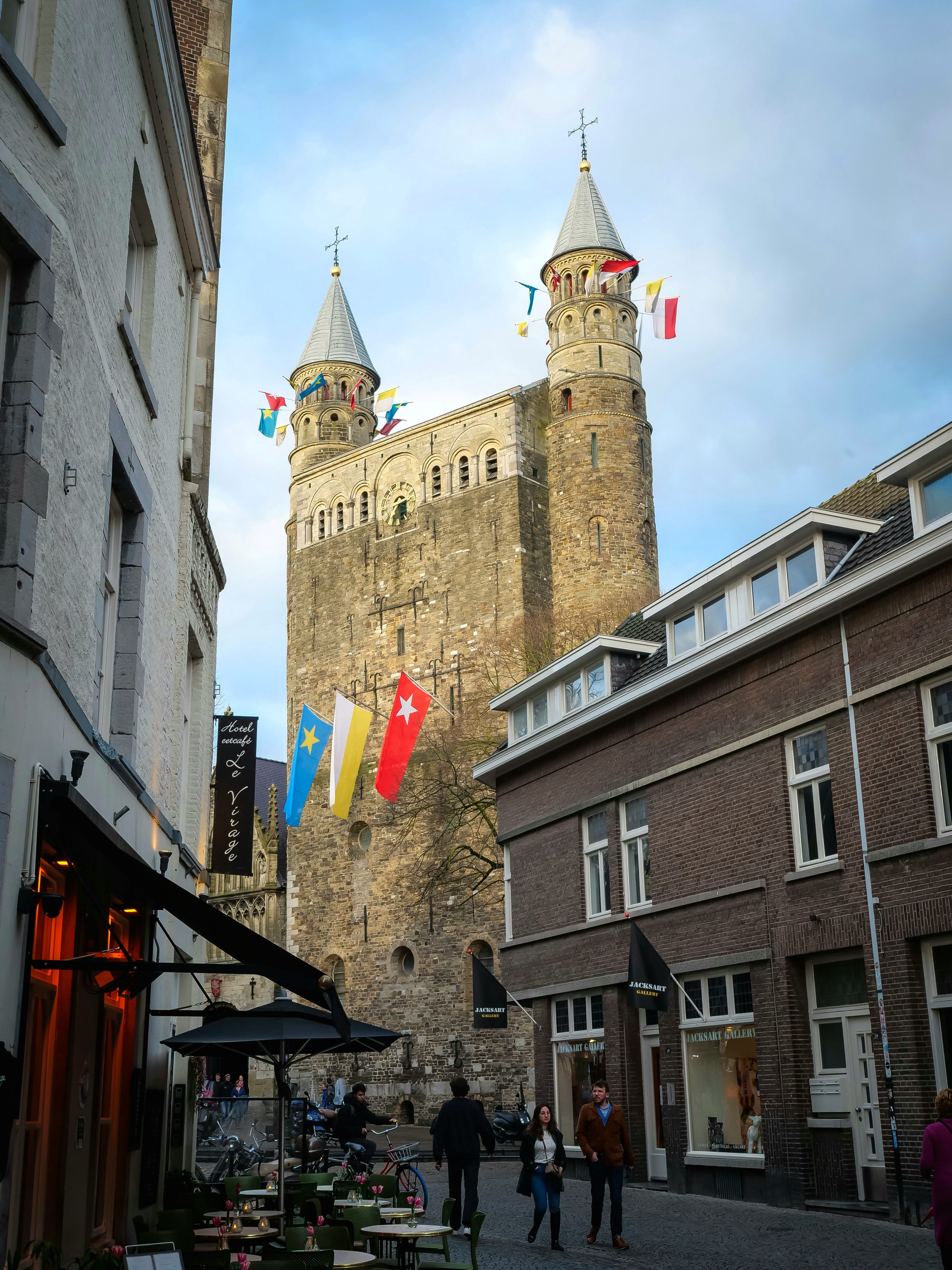 A tall tower with flags flying in the air · Free Stock Photo