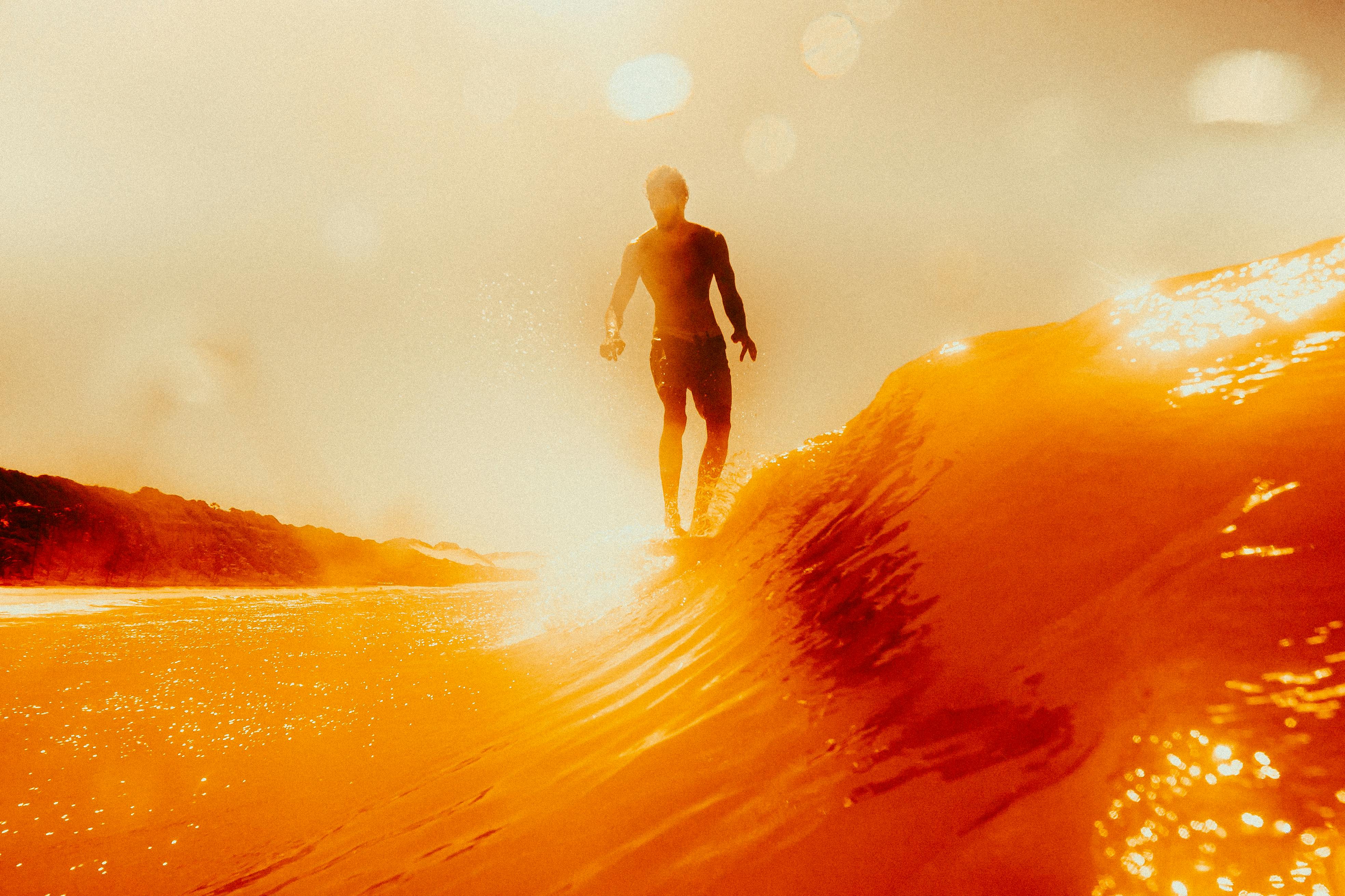 Orange Photography of a Man Surfing · Free Stock Photo