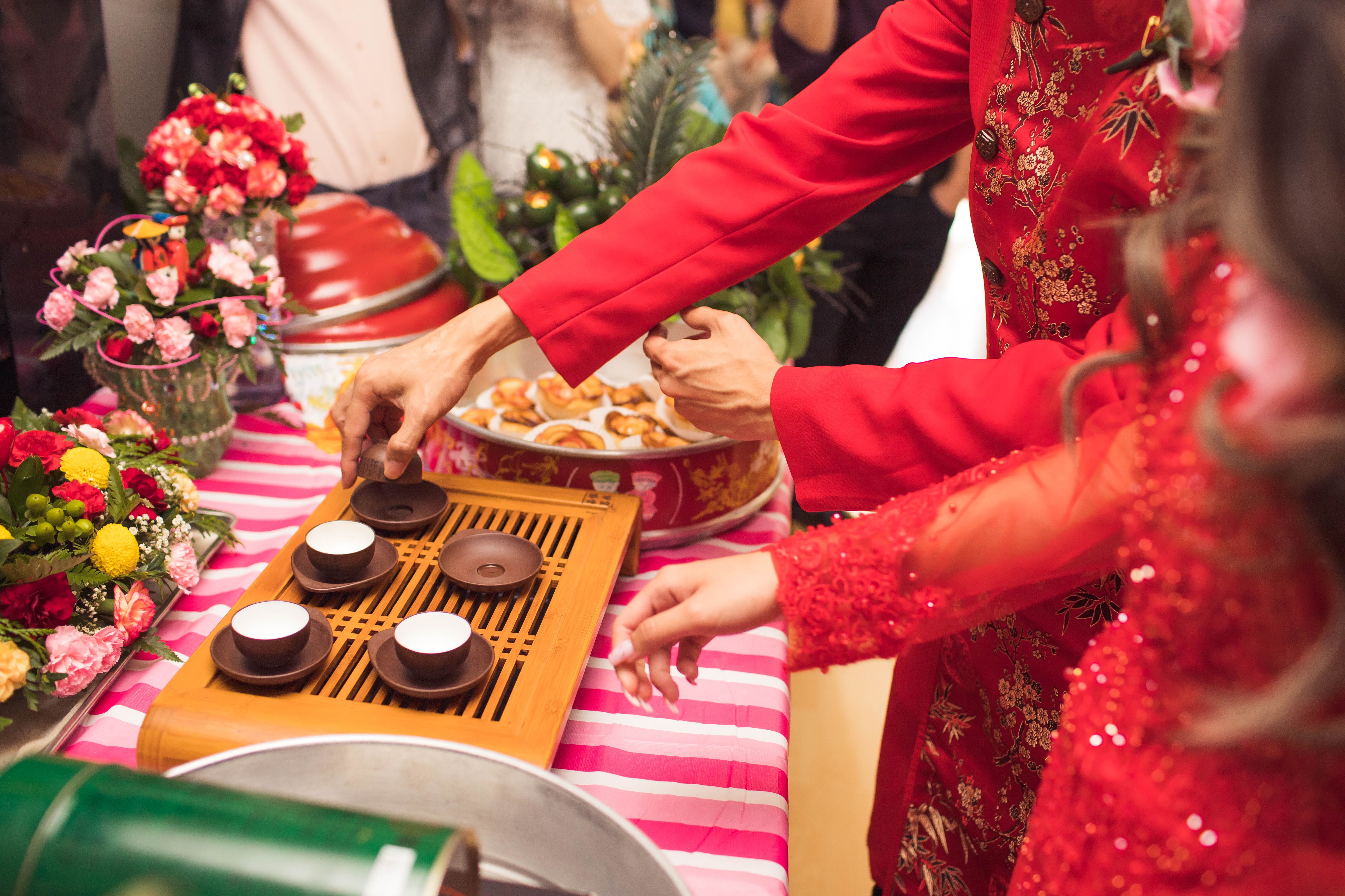 People Reaching for Cups on a Table · Free Stock Photo