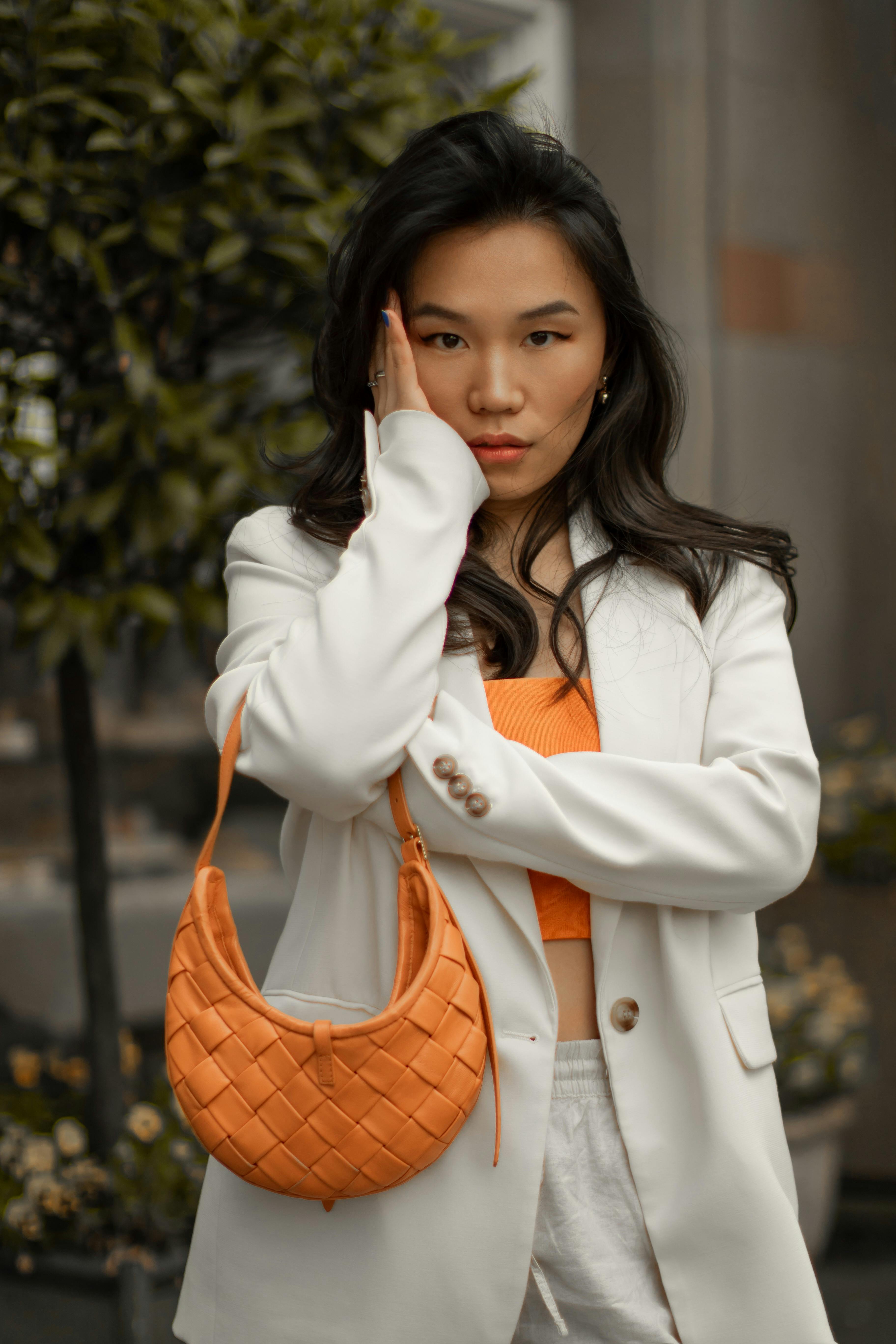 Model in Elegant Blazer Posing with Handbag · Free Stock Photo