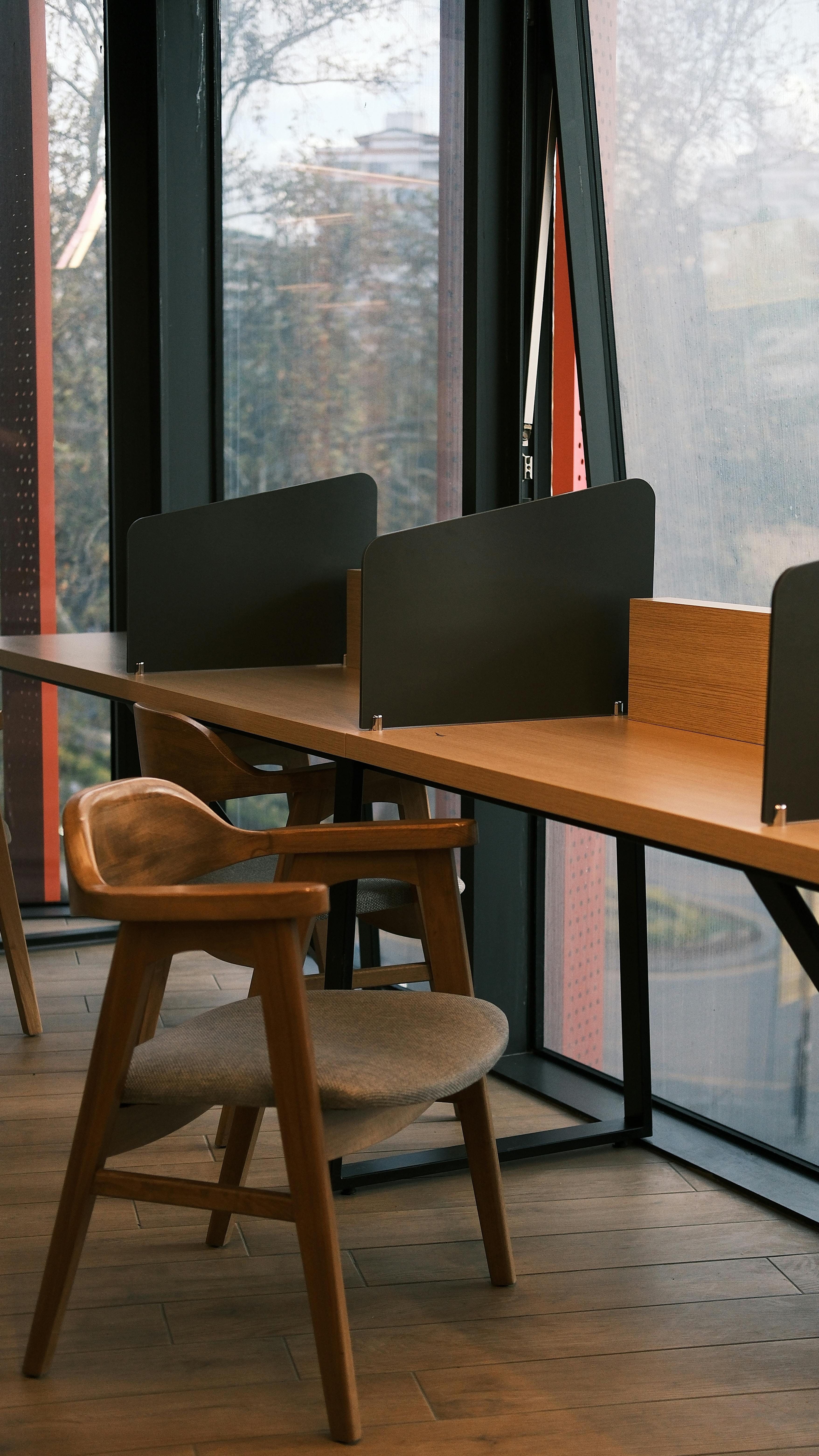 A desk with two chairs and a computer · Free Stock Photo