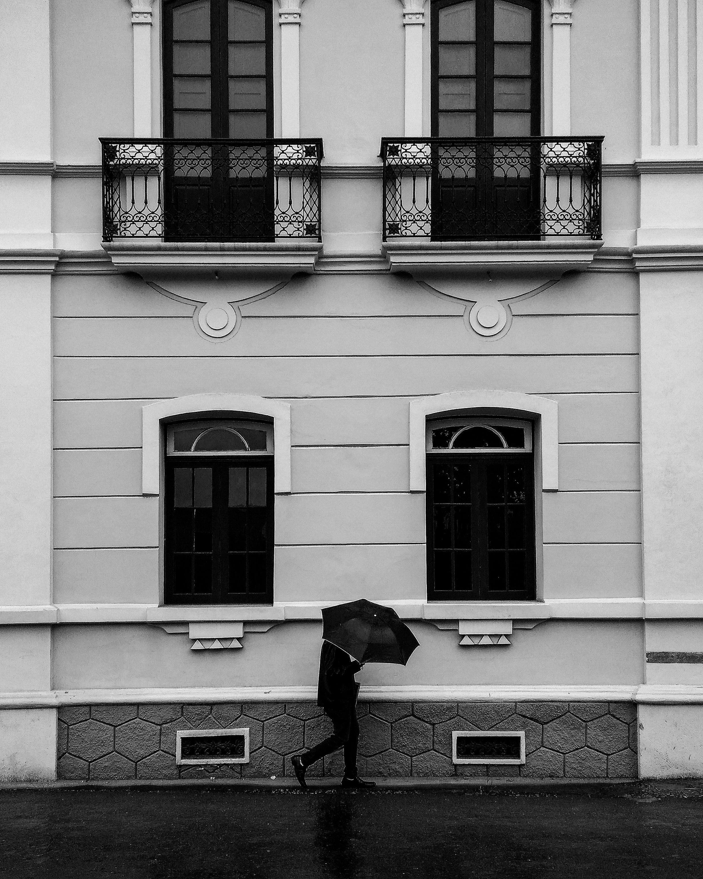 Person Walking Beside Building · Free Stock Photo